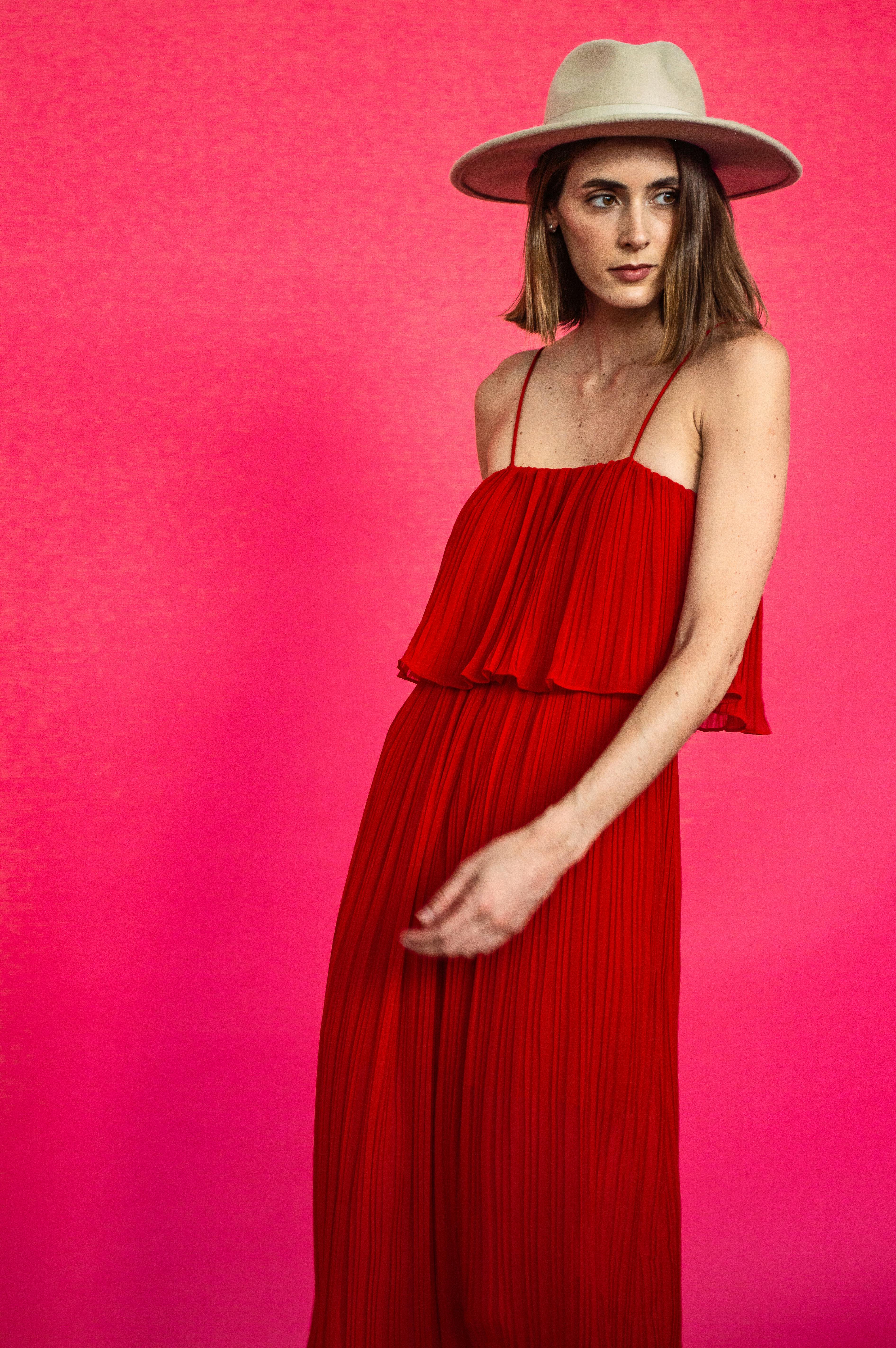 Model Posing in Hat and Ruffled Jumpsuit · Free Stock Photo