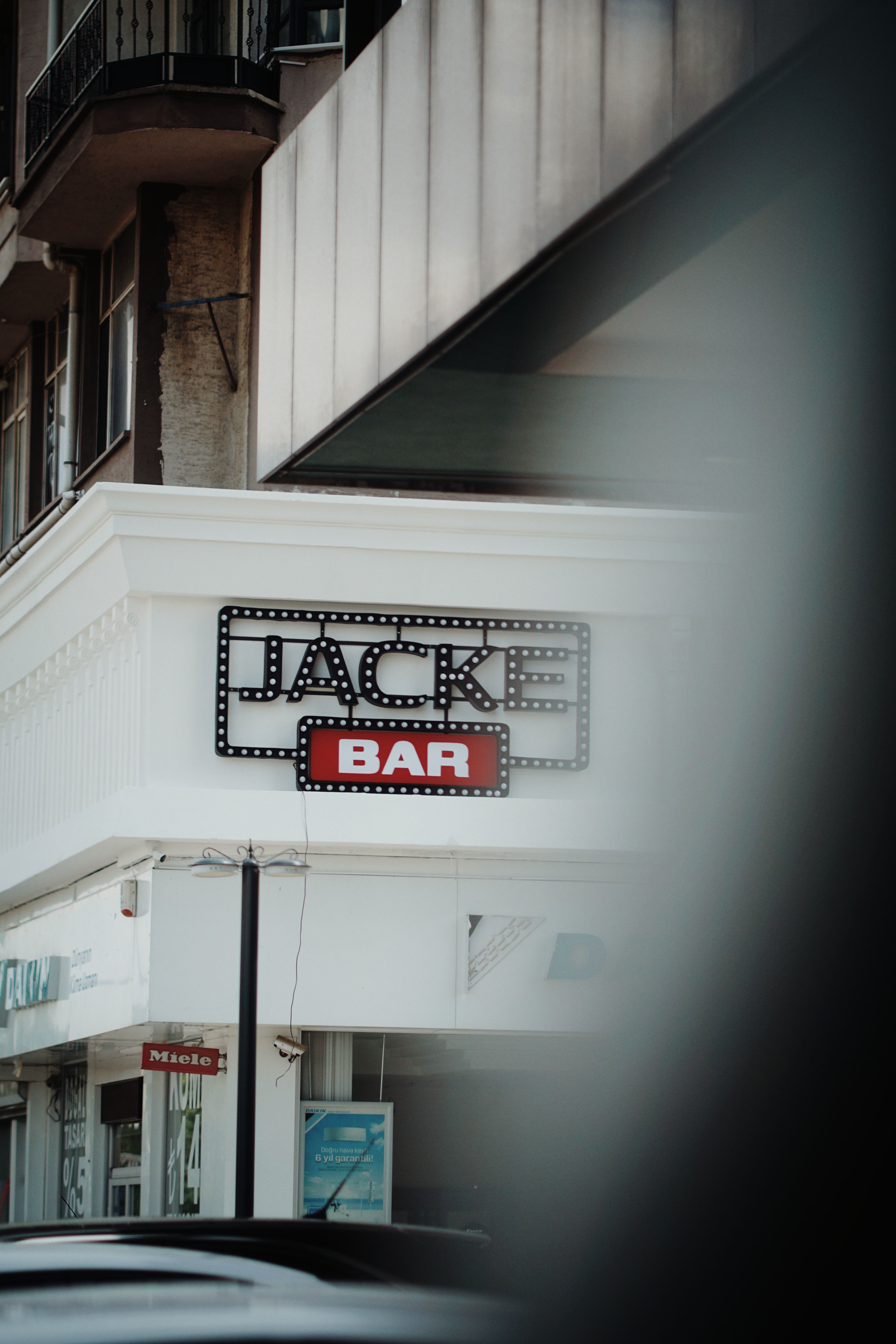 Bar Logo on White Wall · Free Stock Photo