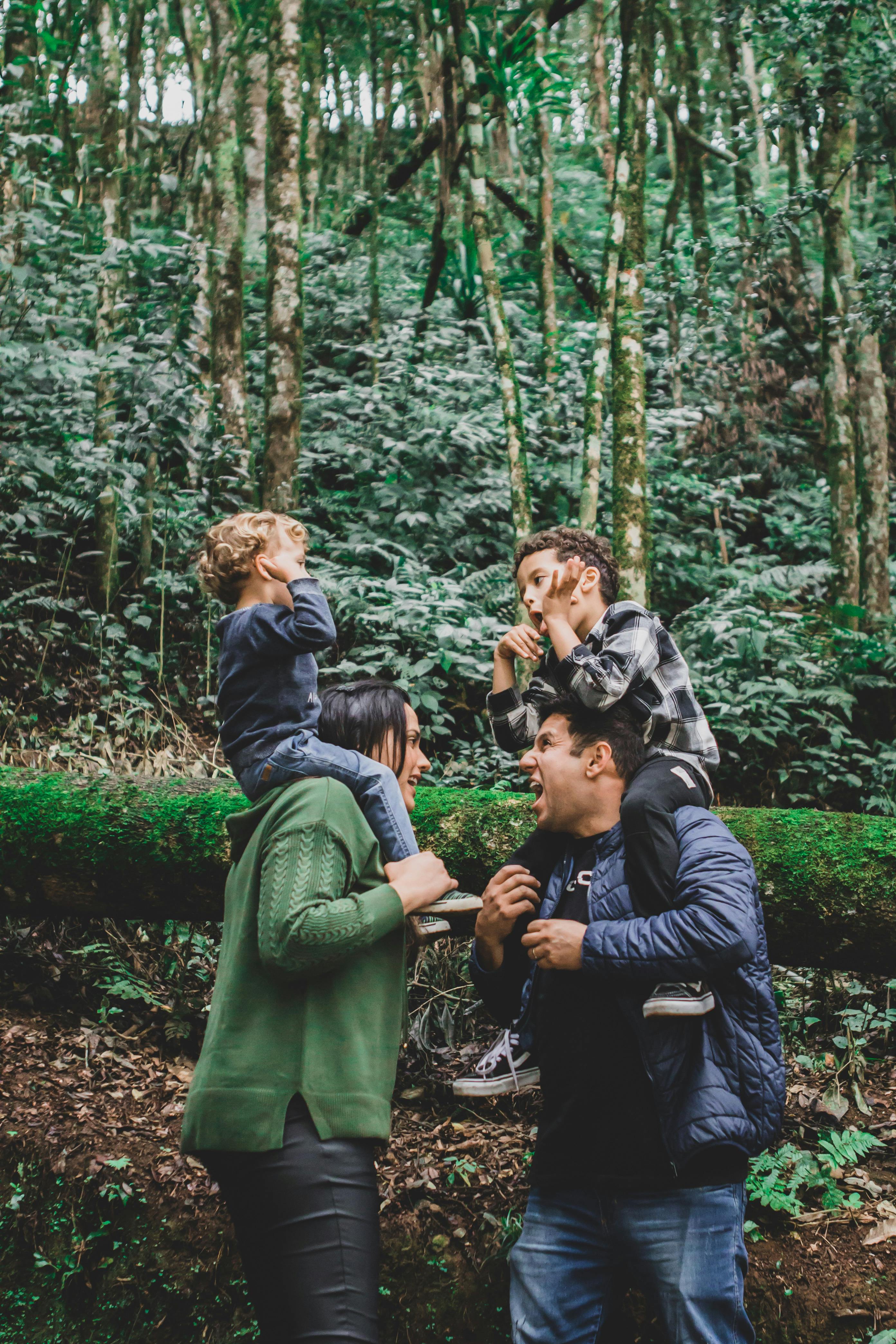 Baby Wearing Blue and Green Rain Coat Picking Brown Dead Tree Branch ...