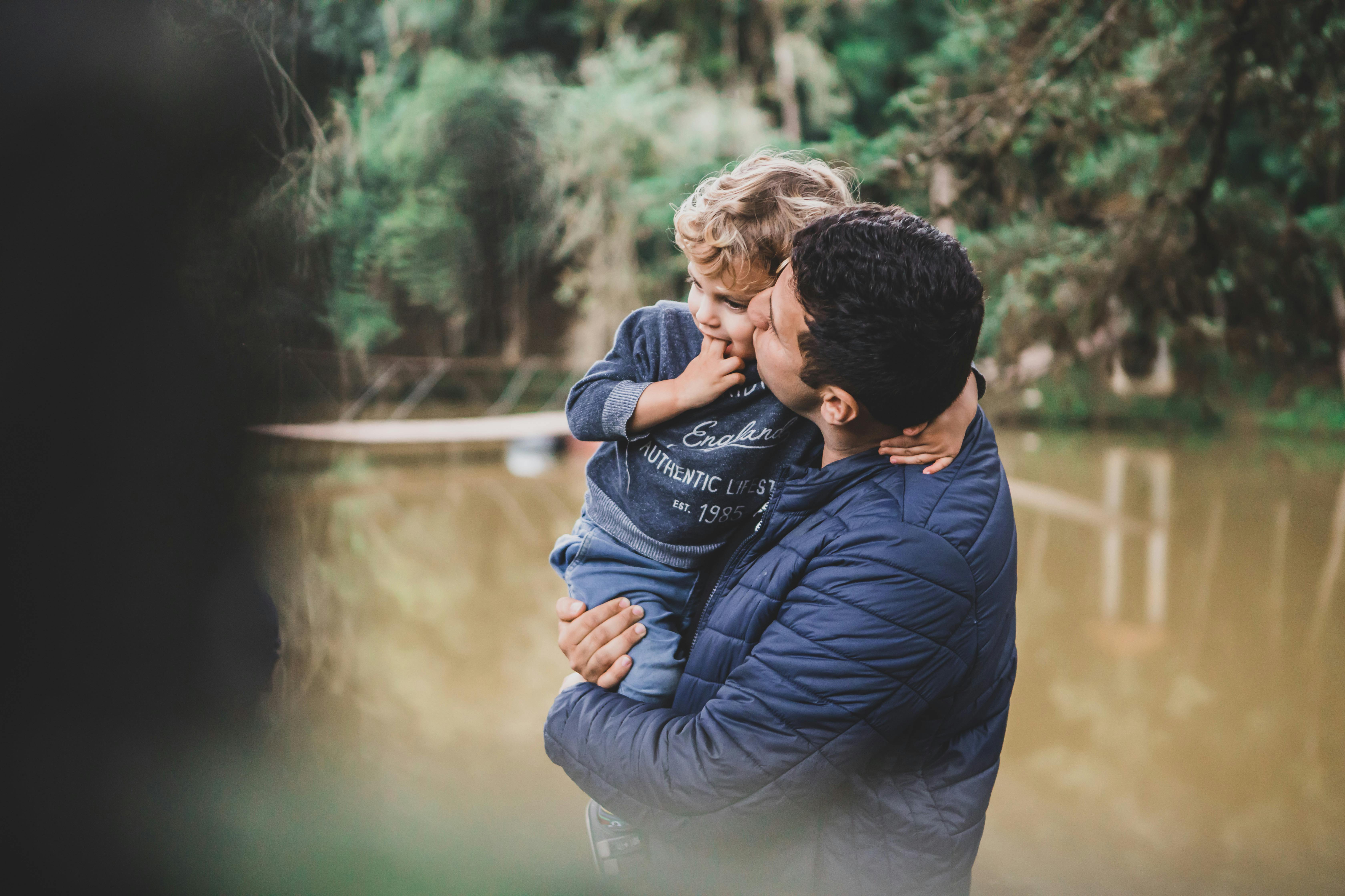 Man Holding His Son · Free Stock Photo