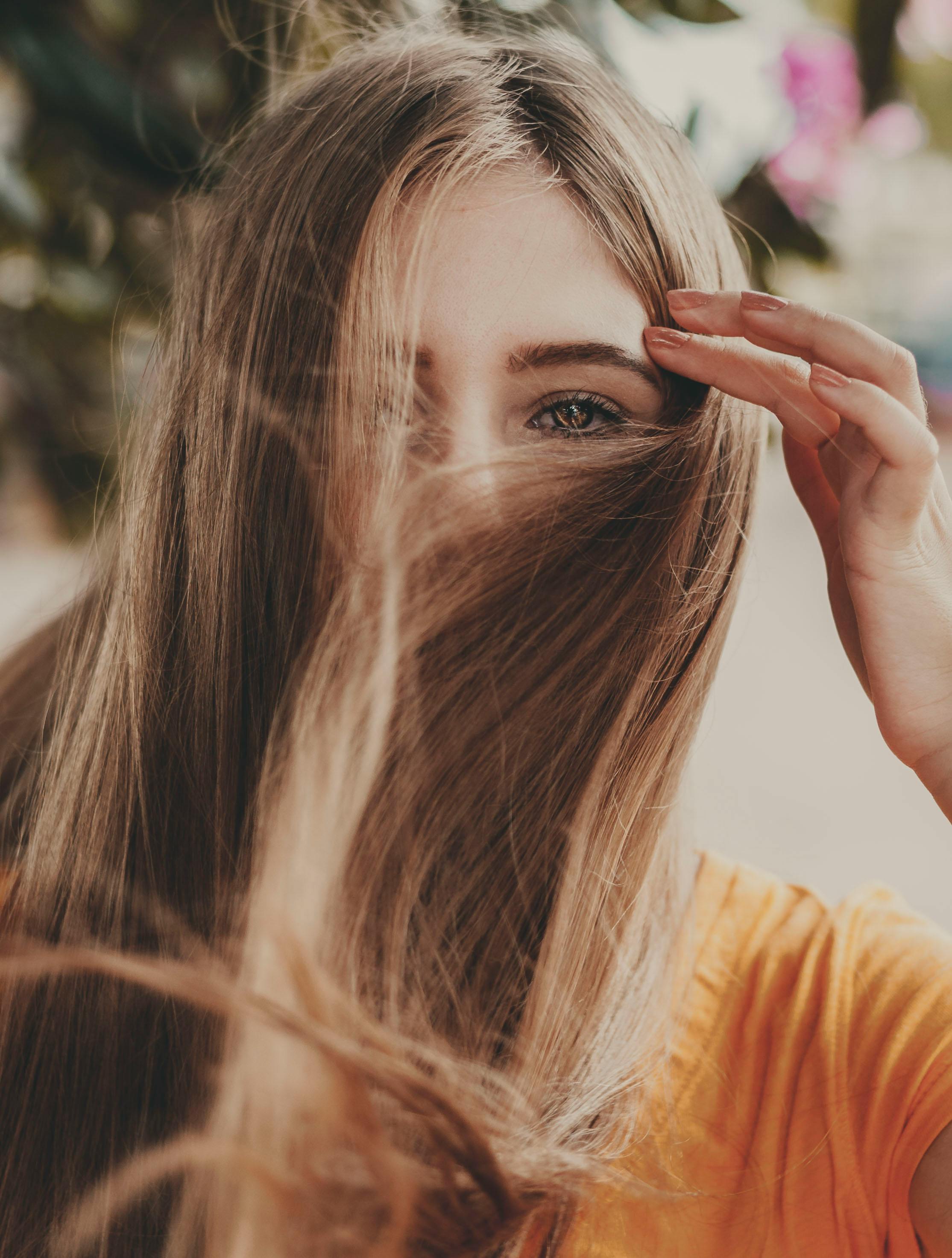A Girl Pushing Her Hair out of Her Face · Free Stock Photo