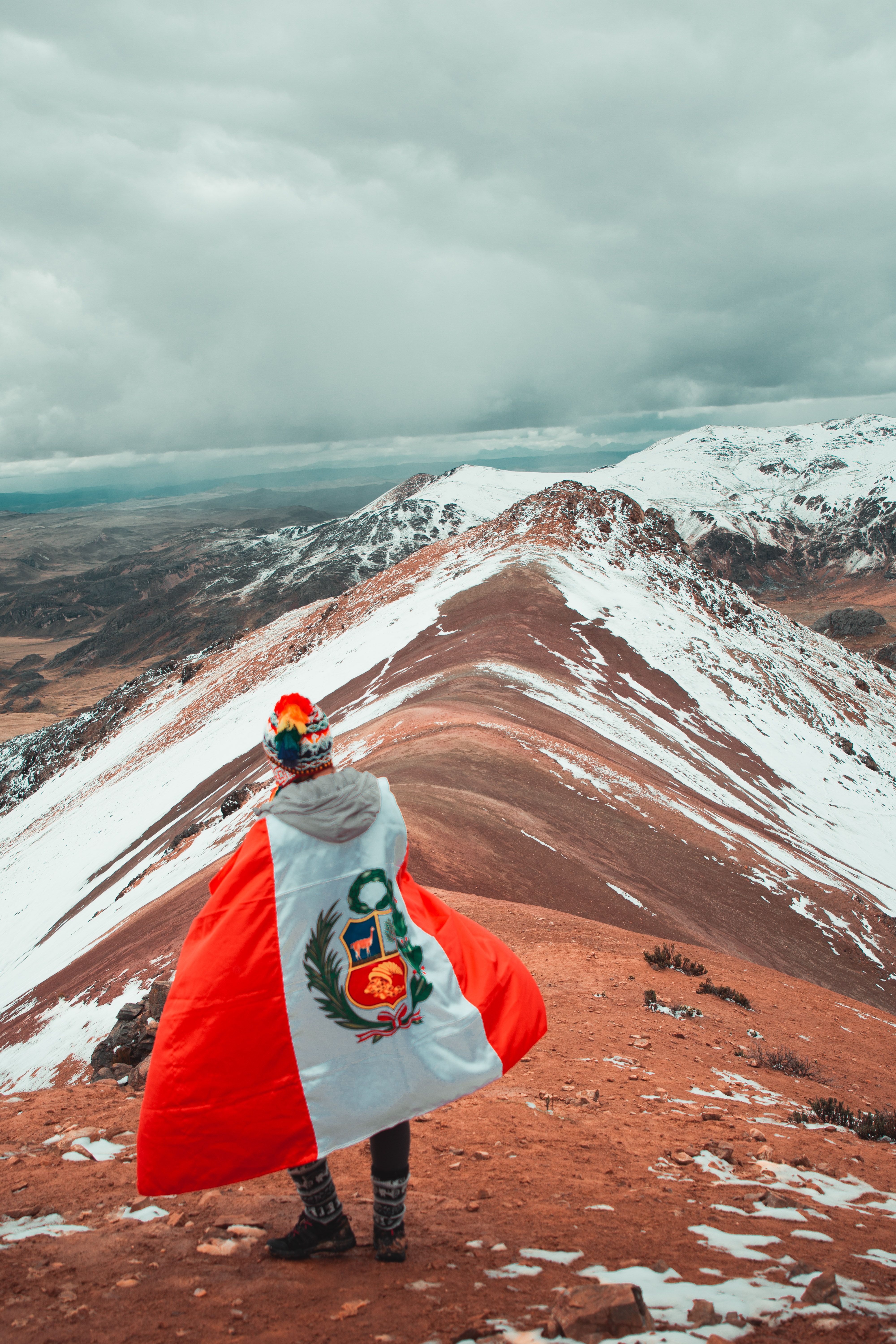 Person with Peruvian Flag in Mountains · Free Stock Photo