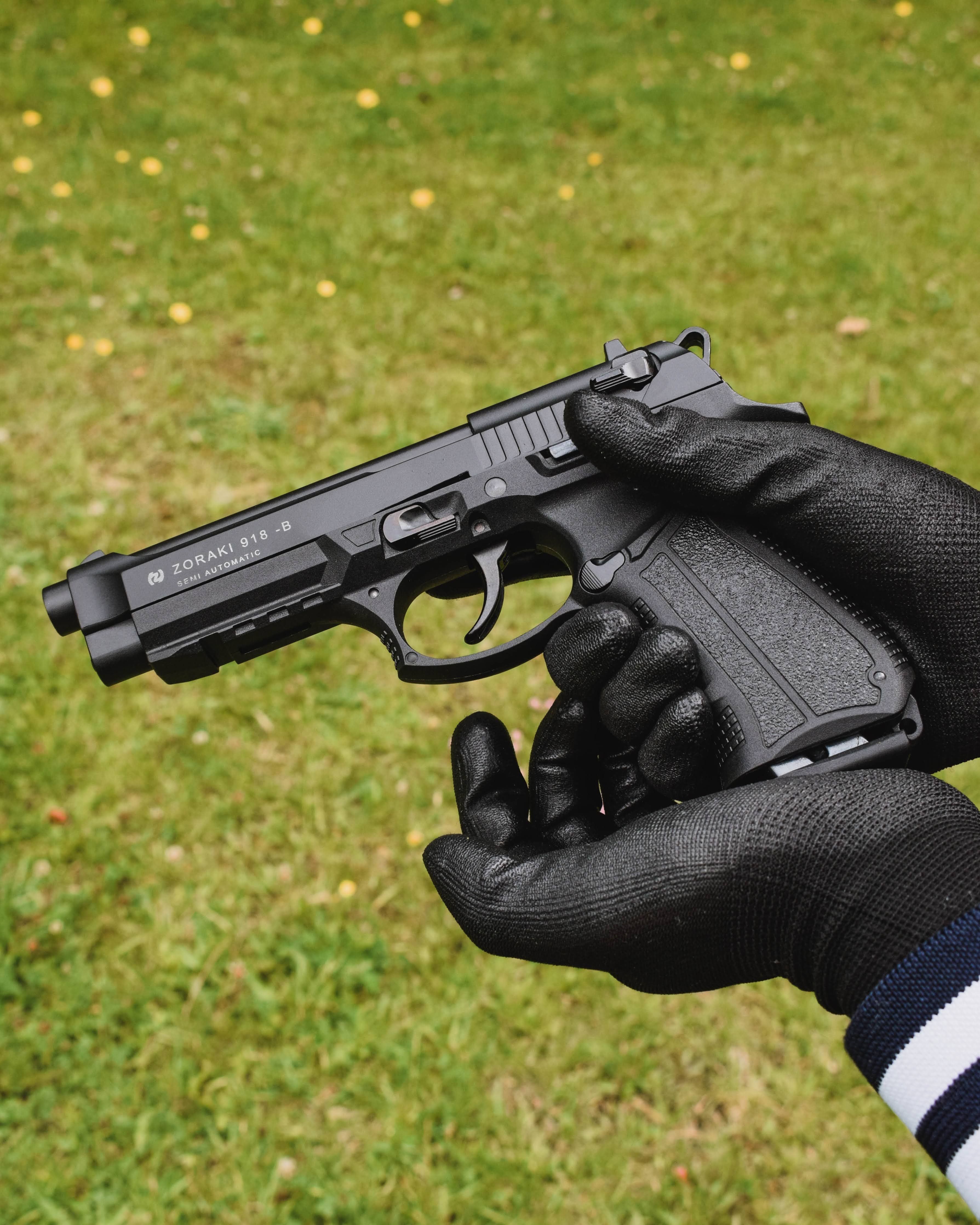 Photo of Hands Holding a Gun · Free Stock Photo