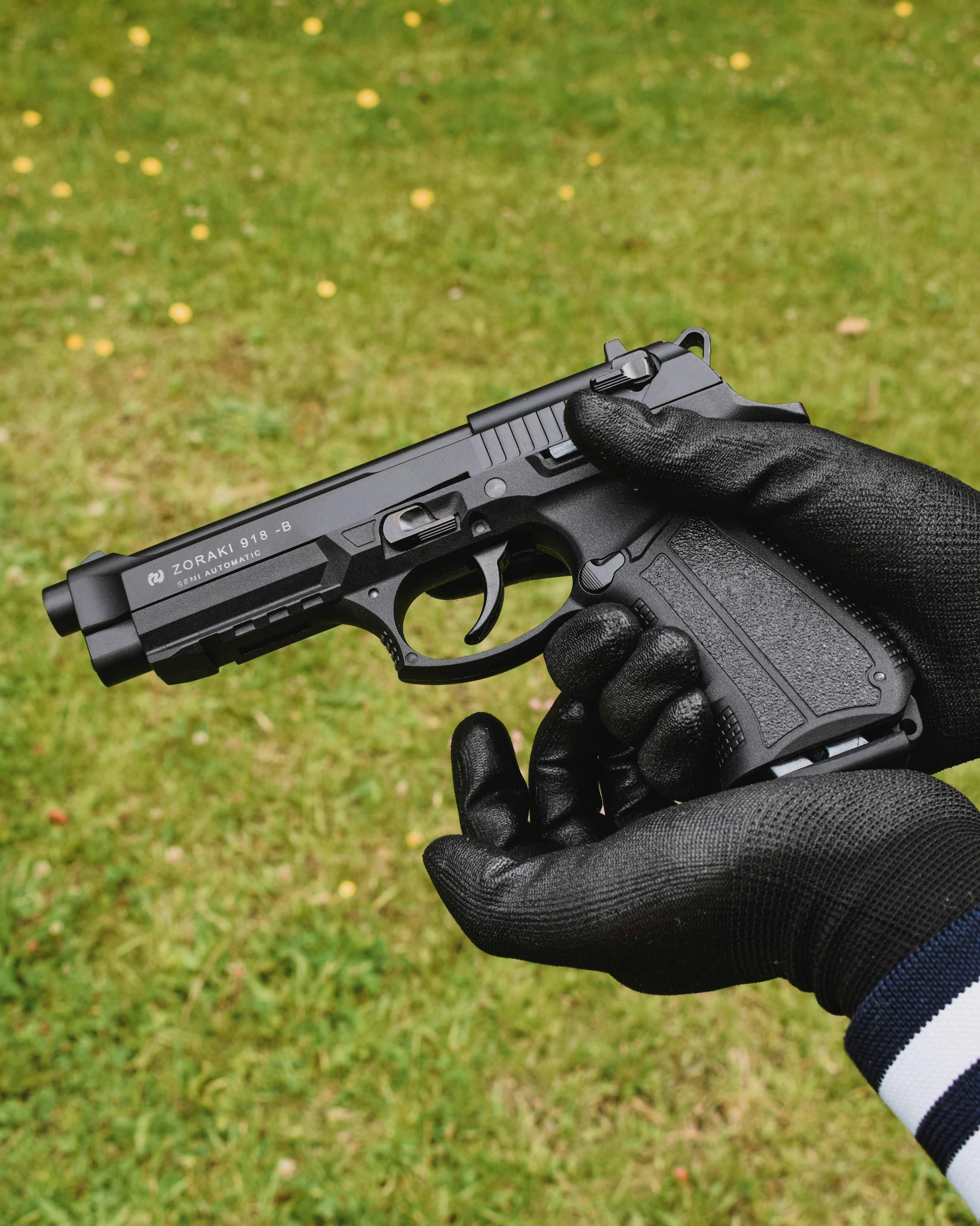 Photo of a Hand Holding a Gun · Free Stock Photo