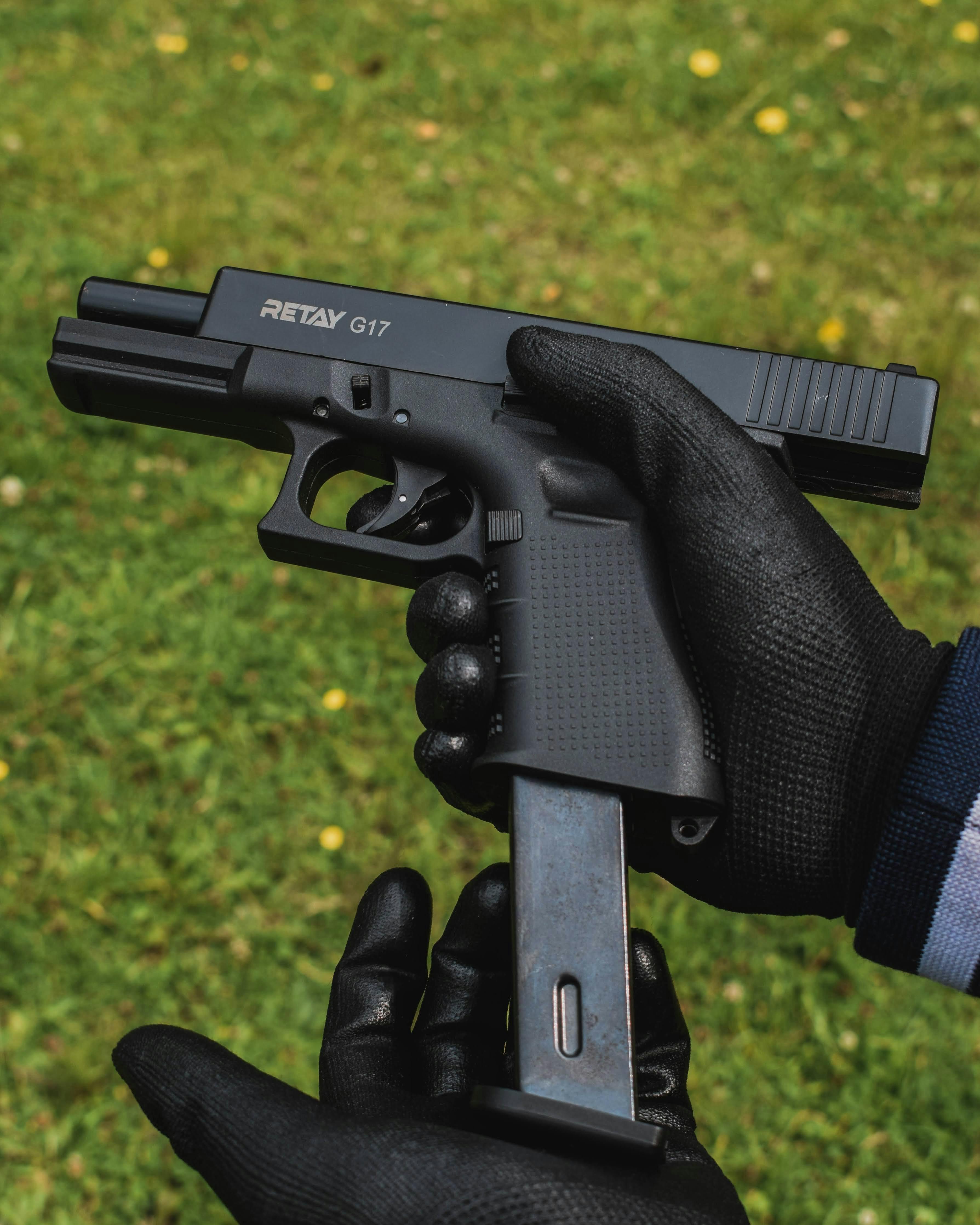 Photo of Gloved Hands Disarming a Gun · Free Stock Photo