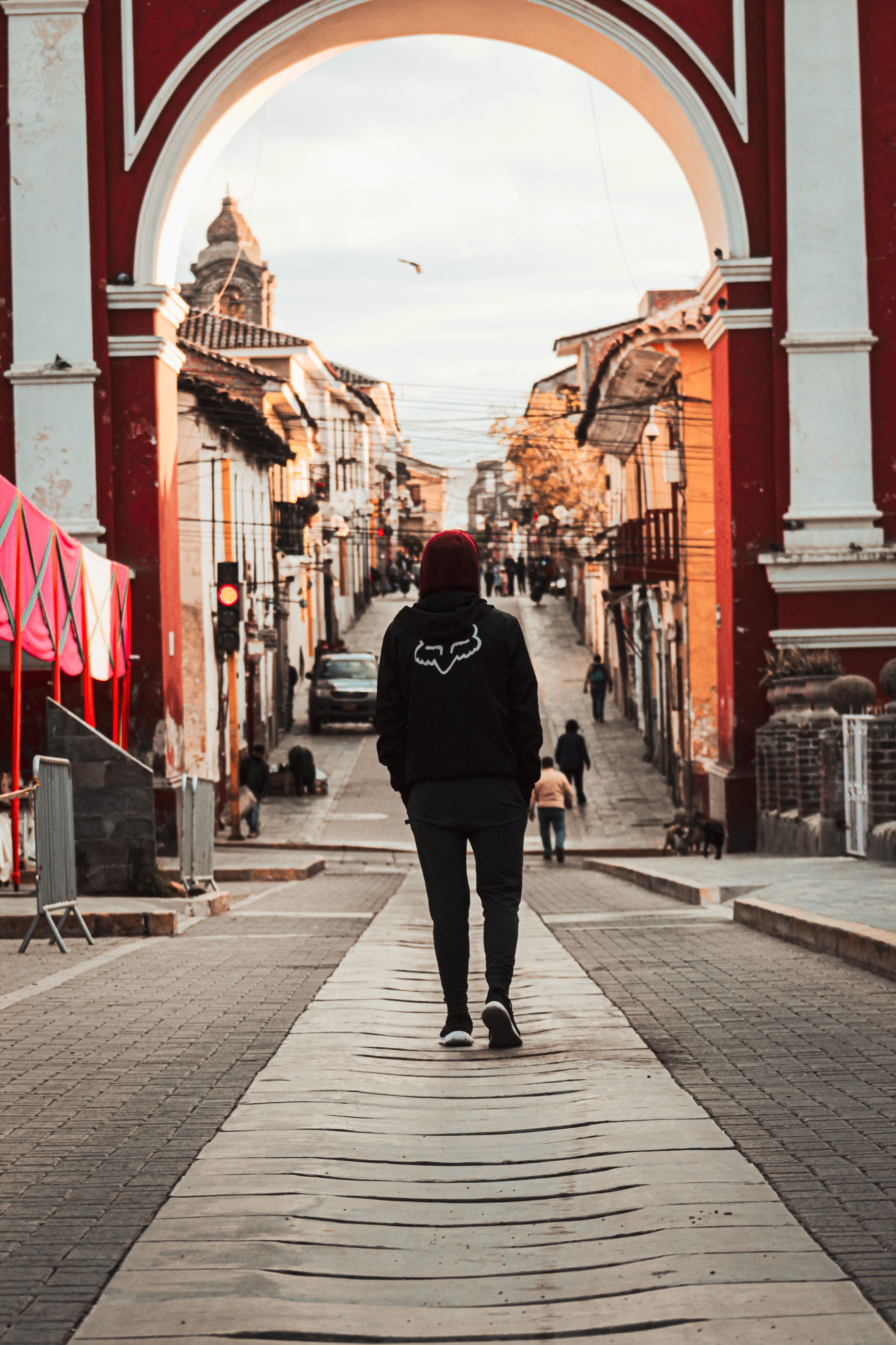 Back View of a Man Walking toward the Arch · Free Stock Photo