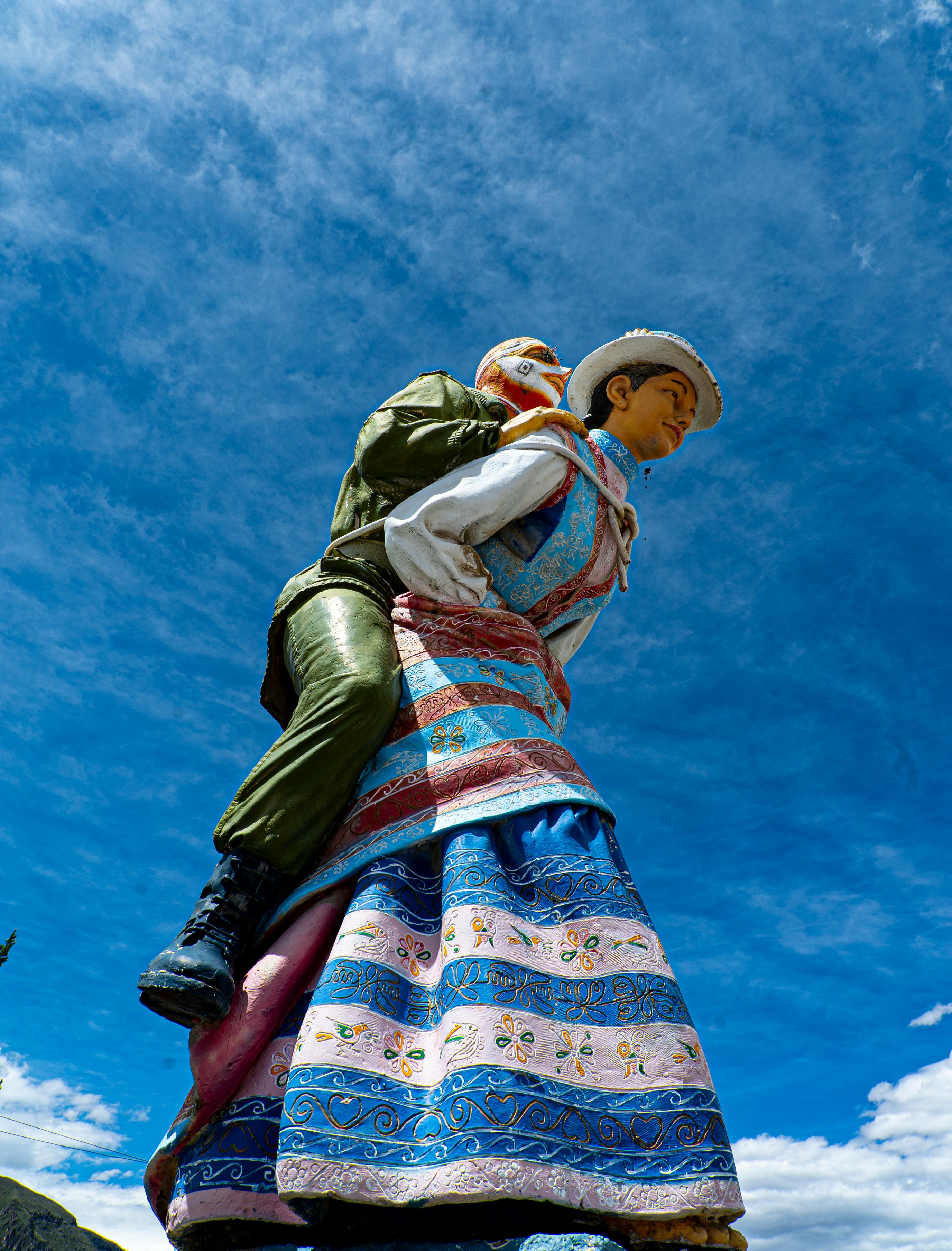 Statue of a Woman with Tied to Her Back a Man in a Costume · Free Stock ...