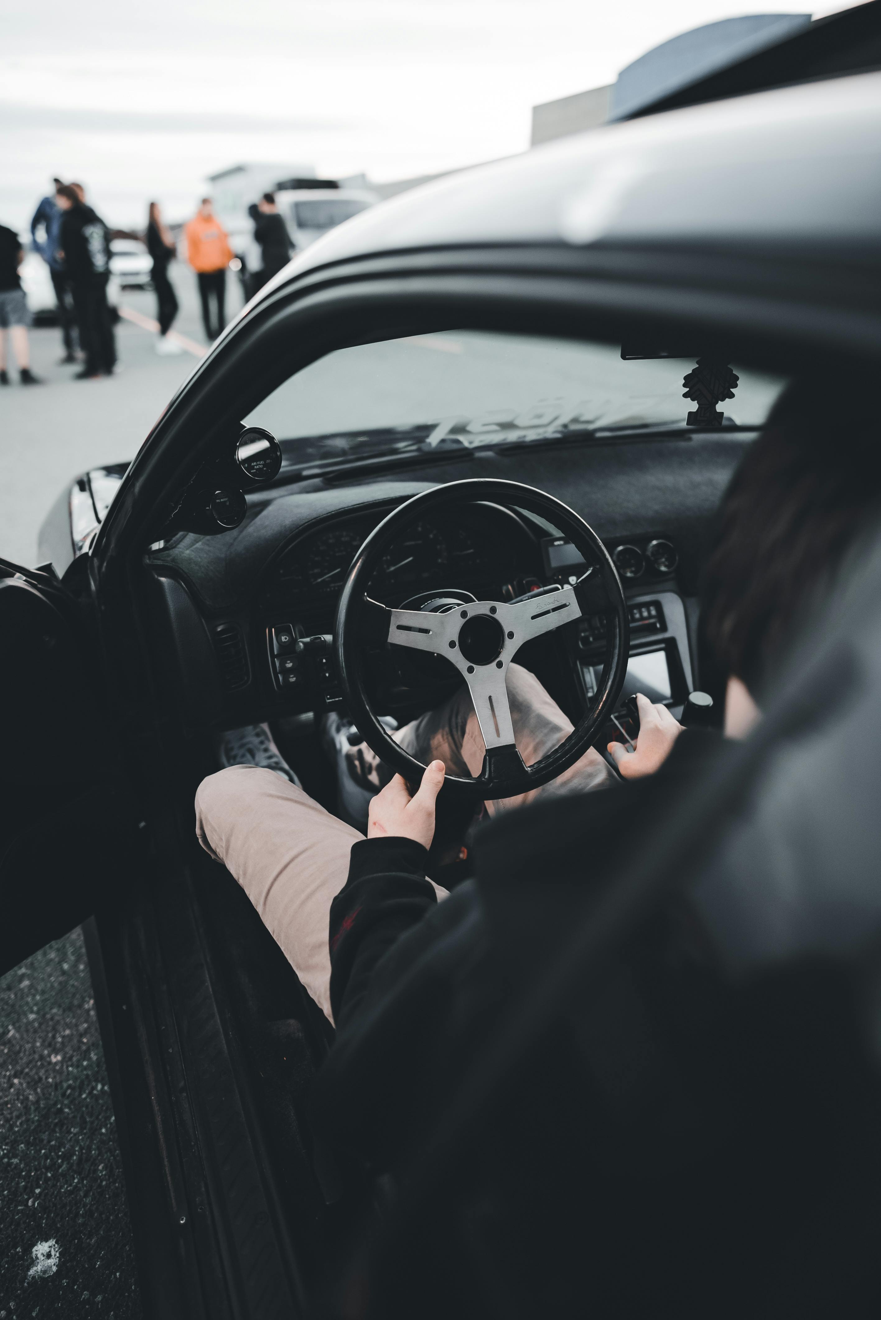 Driver behind Steering Wheel · Free Stock Photo