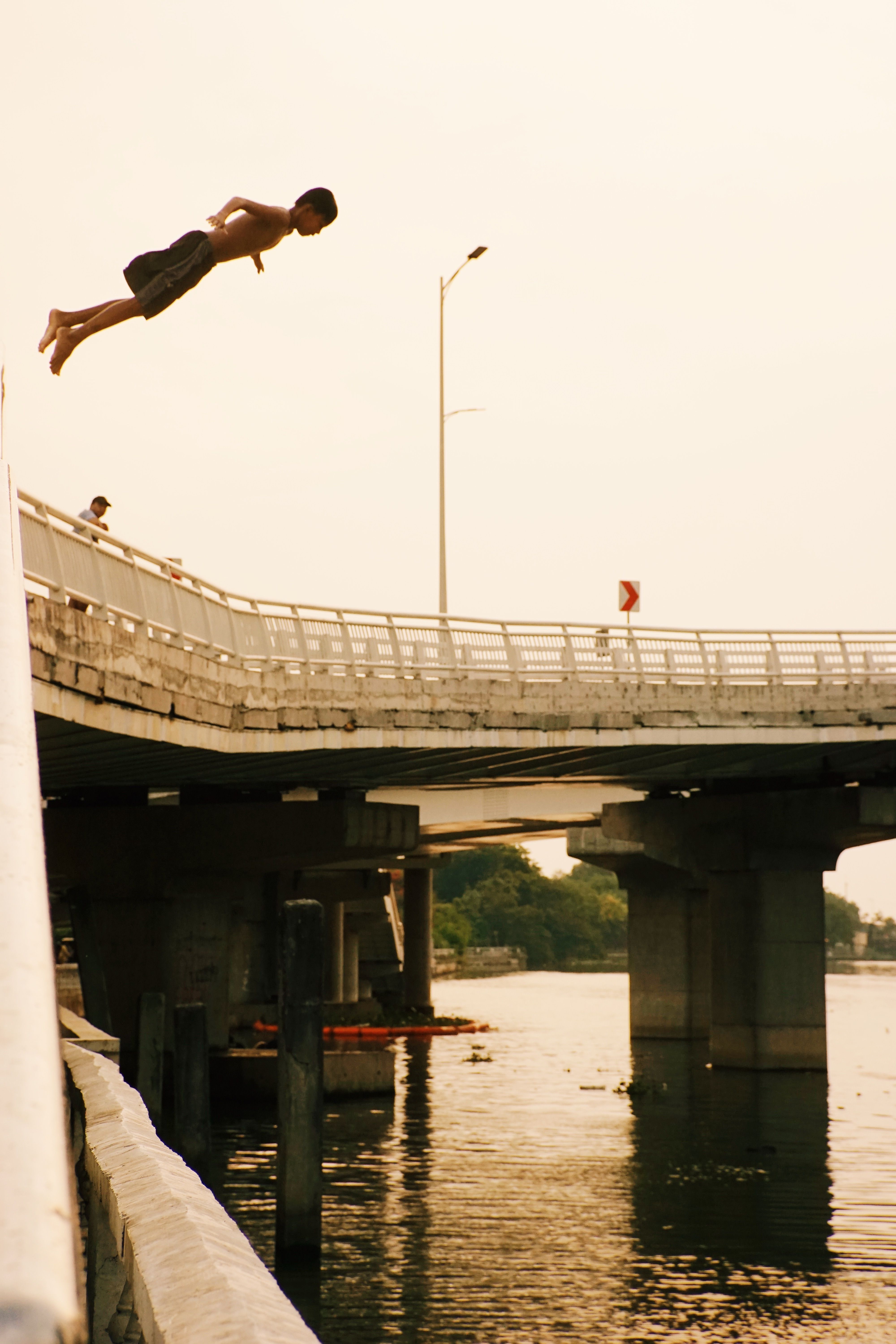 Child Jumping from Bridge · Free Stock Photo