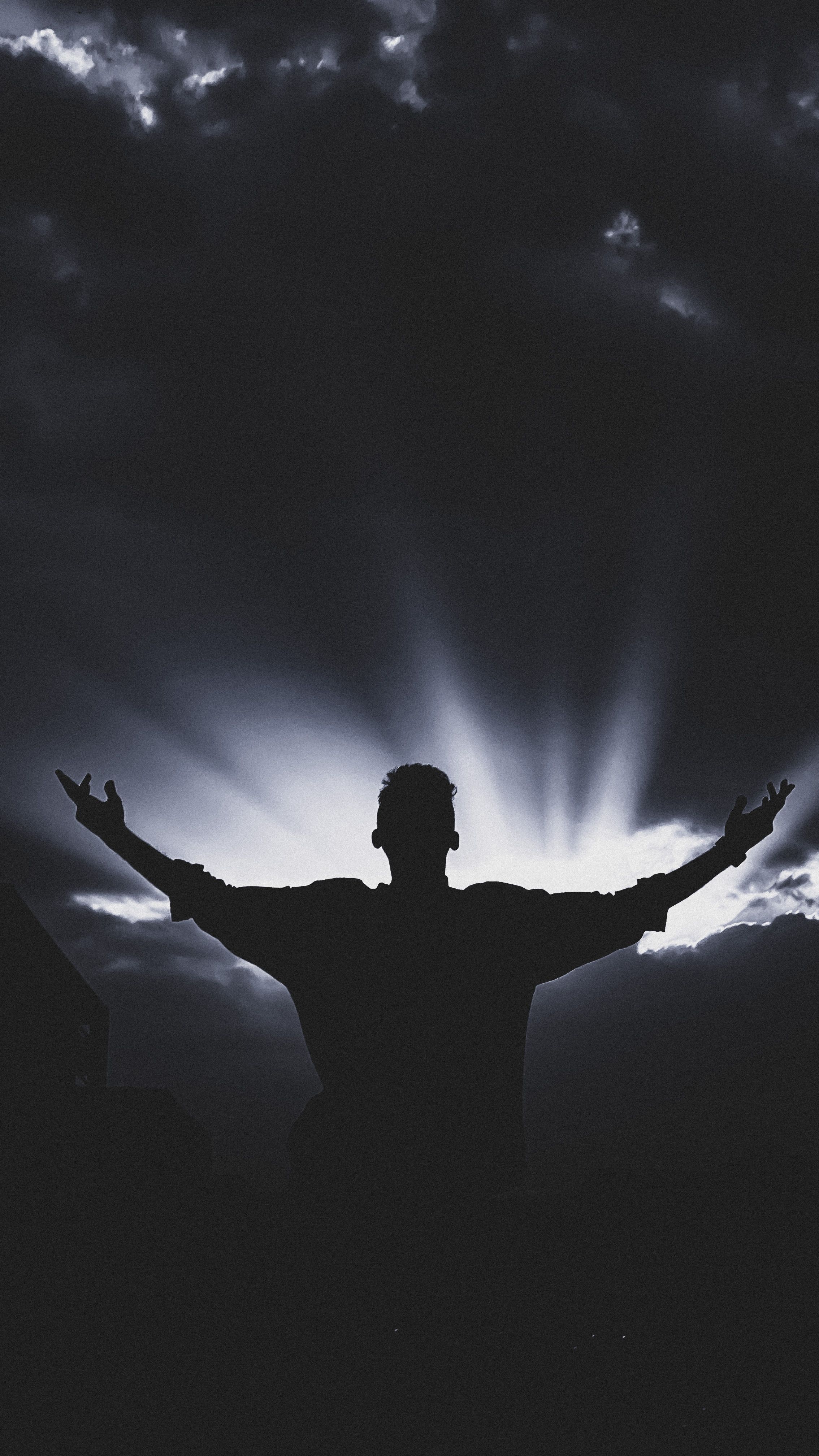 Silhouette of Man with Open Arms against Dramatic Sunset · Free Stock Photo