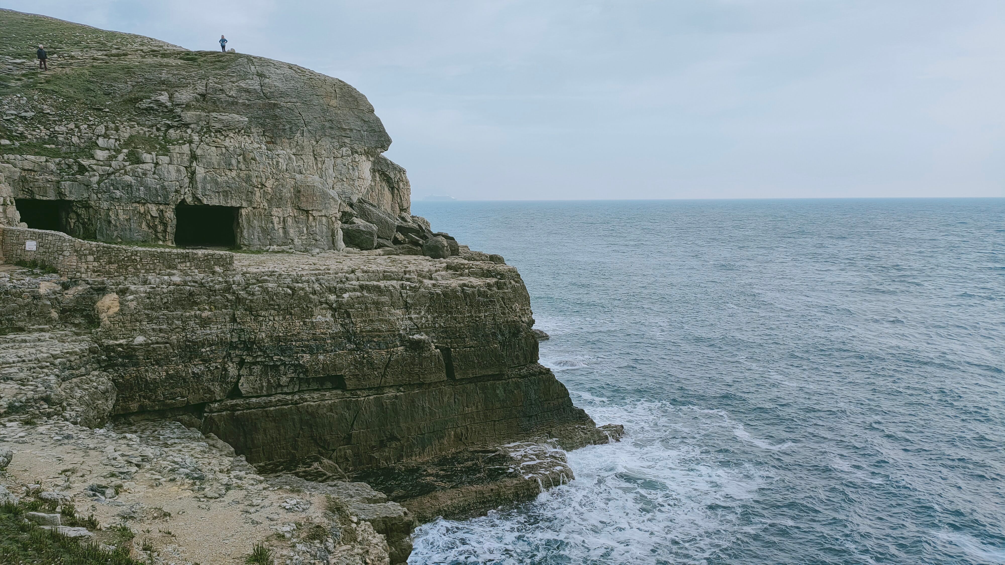 People Walking on Cliff near Sea · Free Stock Photo