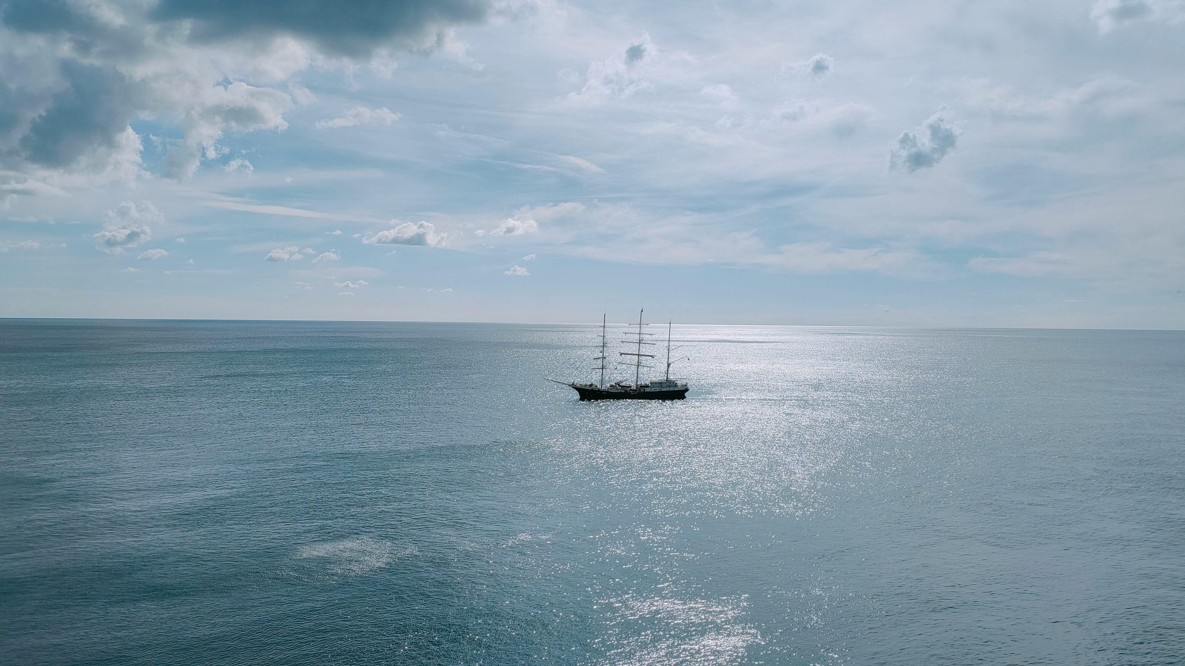 Sailboat on Open Sea under Cloudy Sky · Free Stock Photo