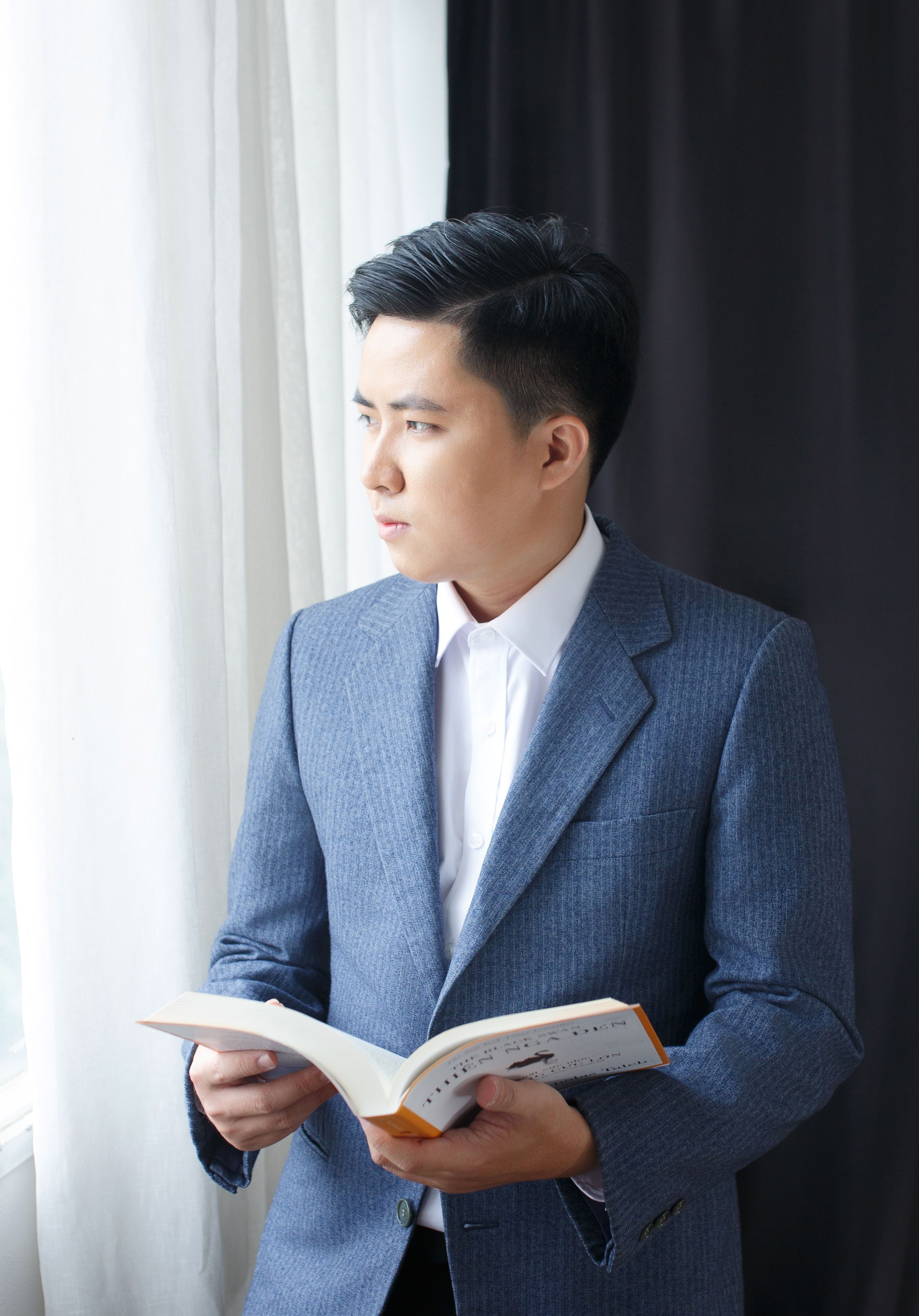 Elegant man with book on sofa · Free Stock Photo