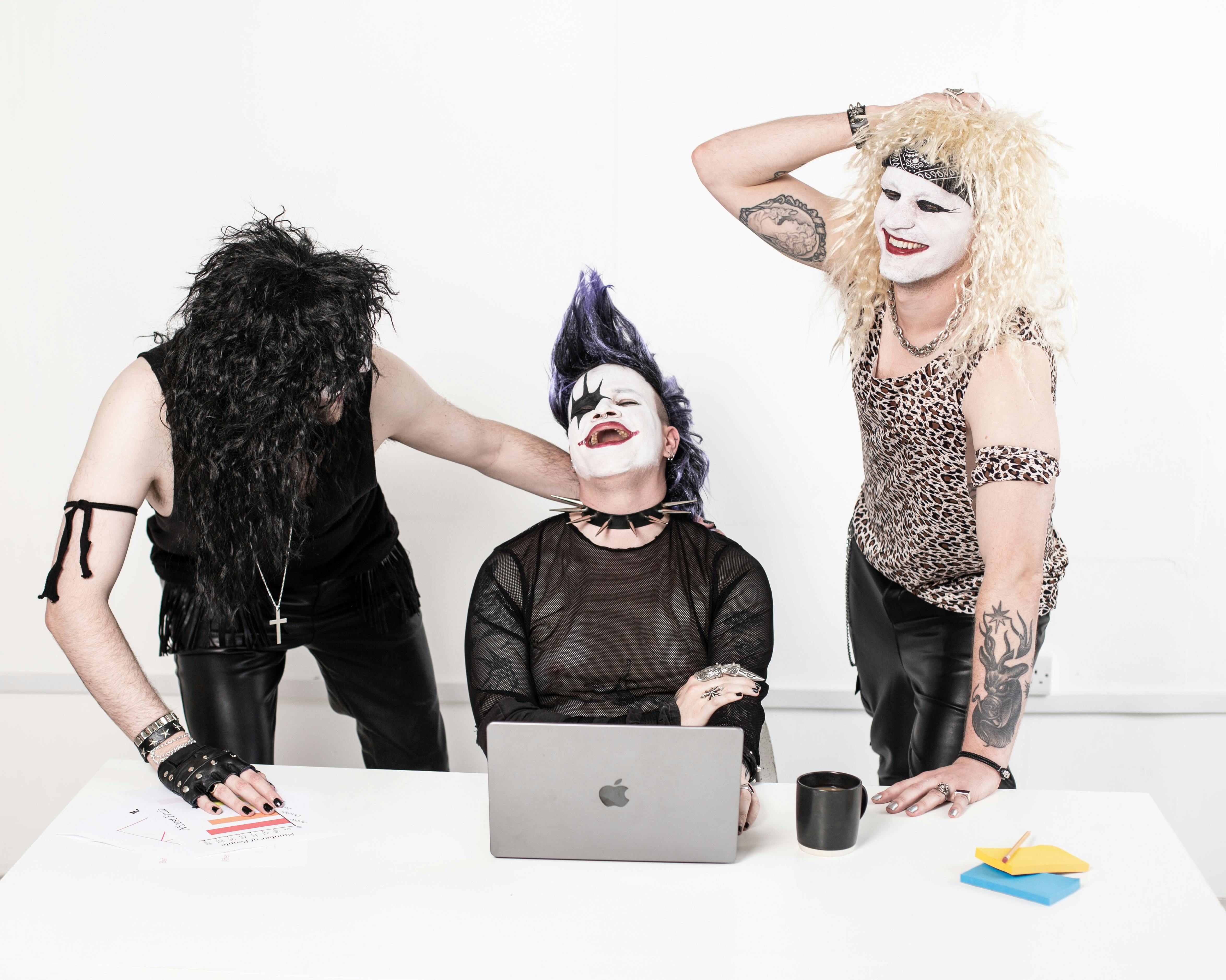 A Group of Men Wearing Goth Style Clothes and Makeup Laughing in front ...