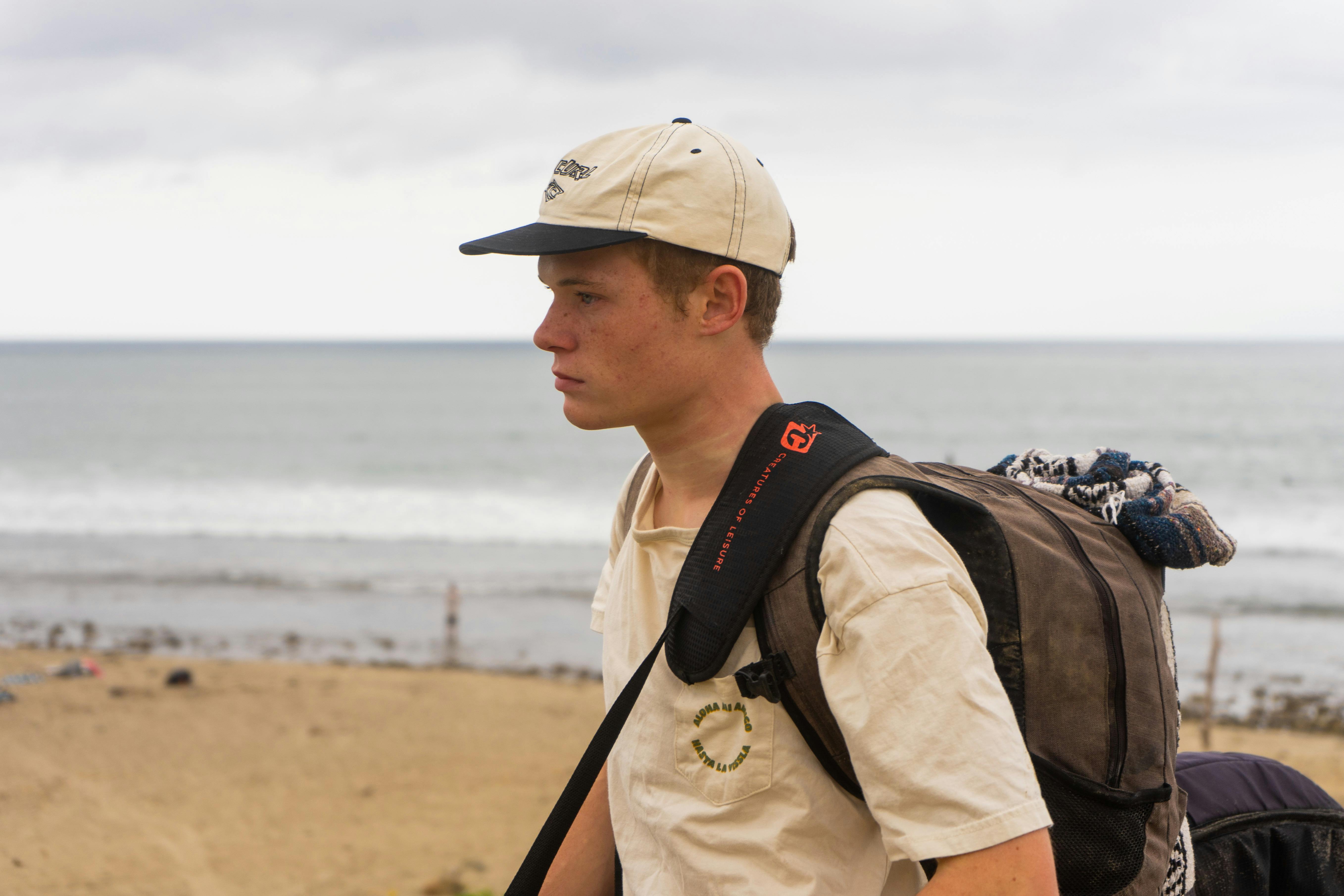 Portrait of a Male Backpacker at a Beach · Free Stock Photo
