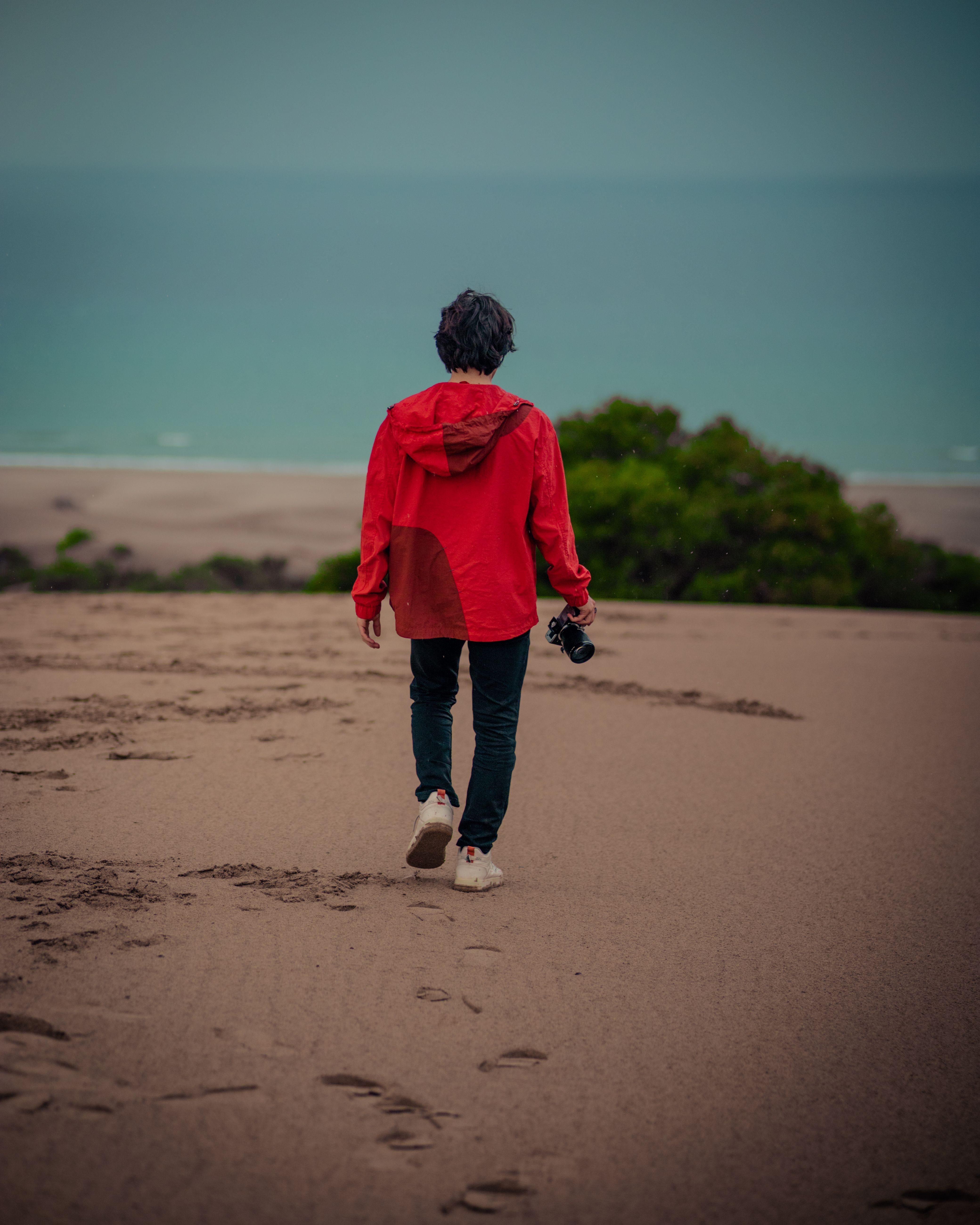 Man Walking with Camera on Beach · Free Stock Photo
