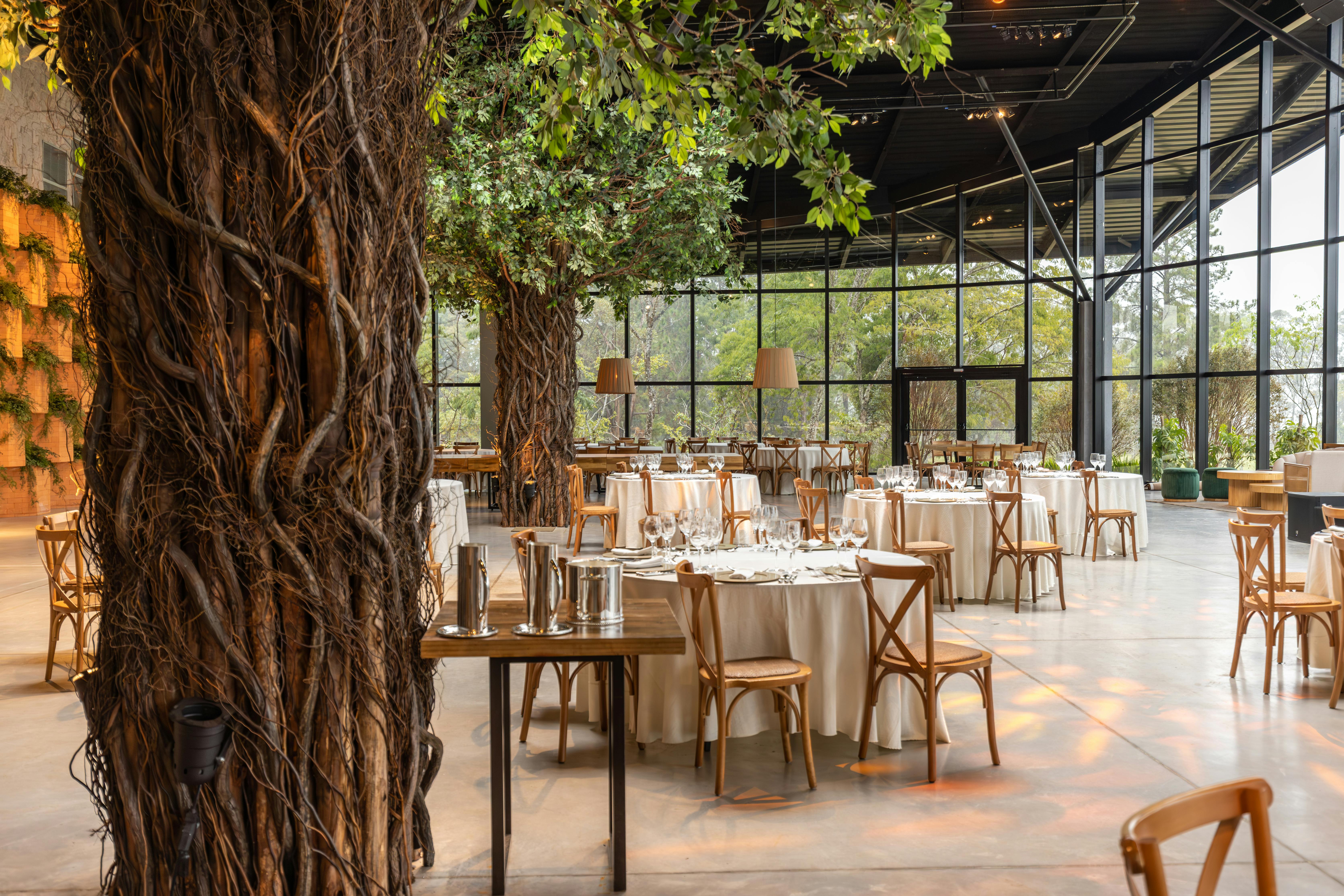 Glazed Restaurant Hall with Indoor Trees · Free Stock Photo