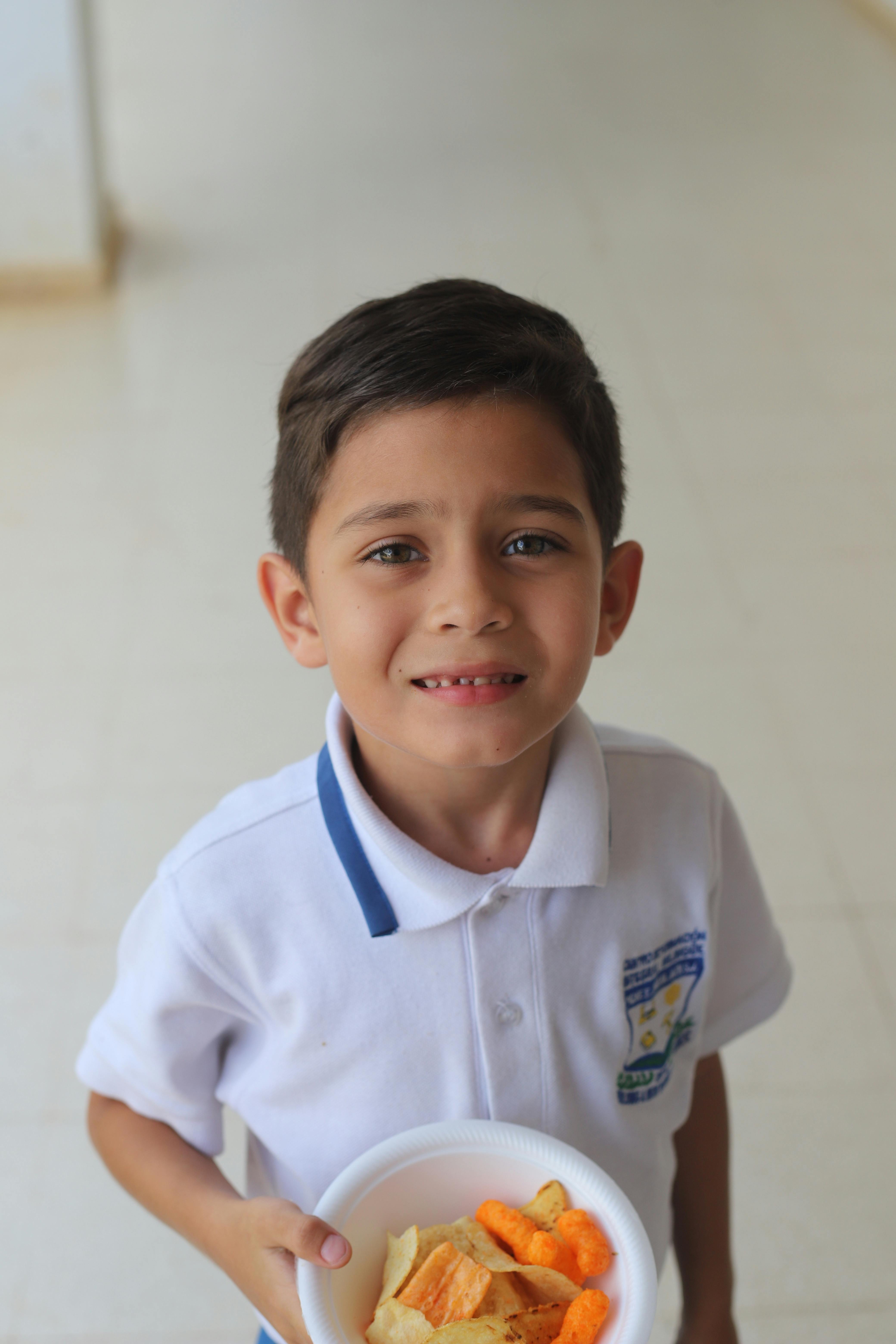 Boy Holding Bowl with Unhealthy Food · Free Stock Photo