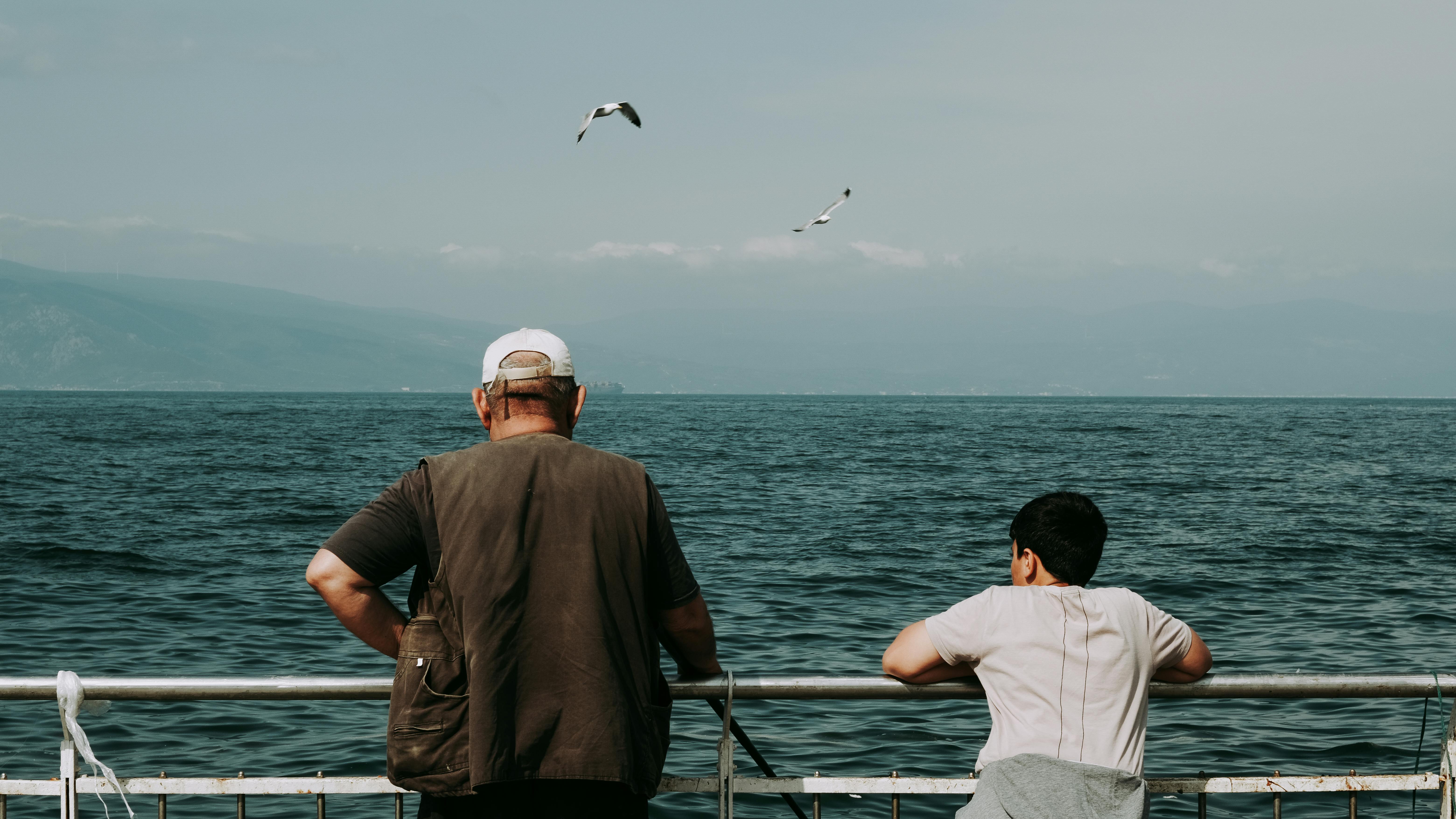 Man and Boy on Ship Looking at Sea · Free Stock Photo