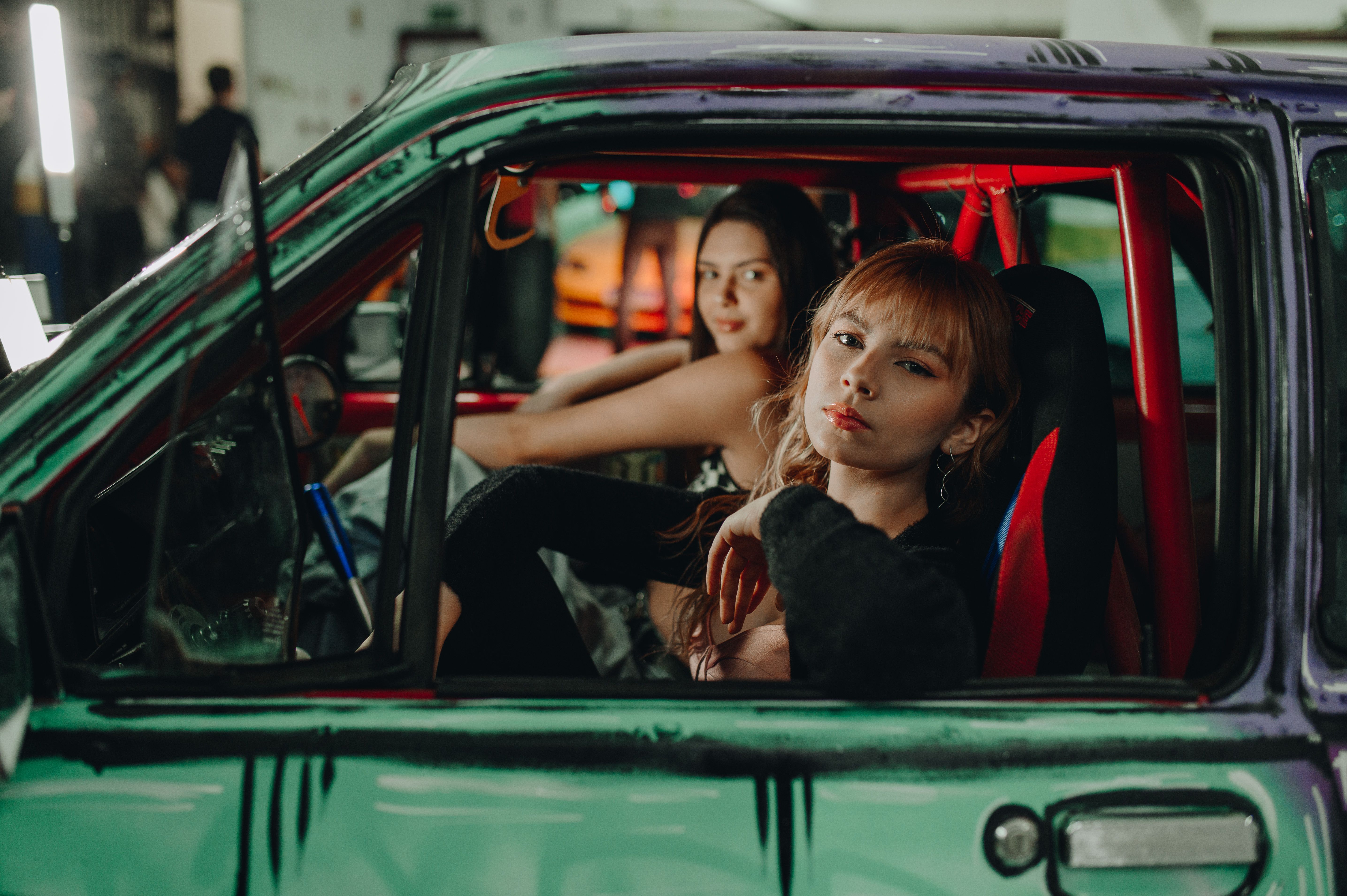 Young Women Sitting in a Custom Car · Free Stock Photo