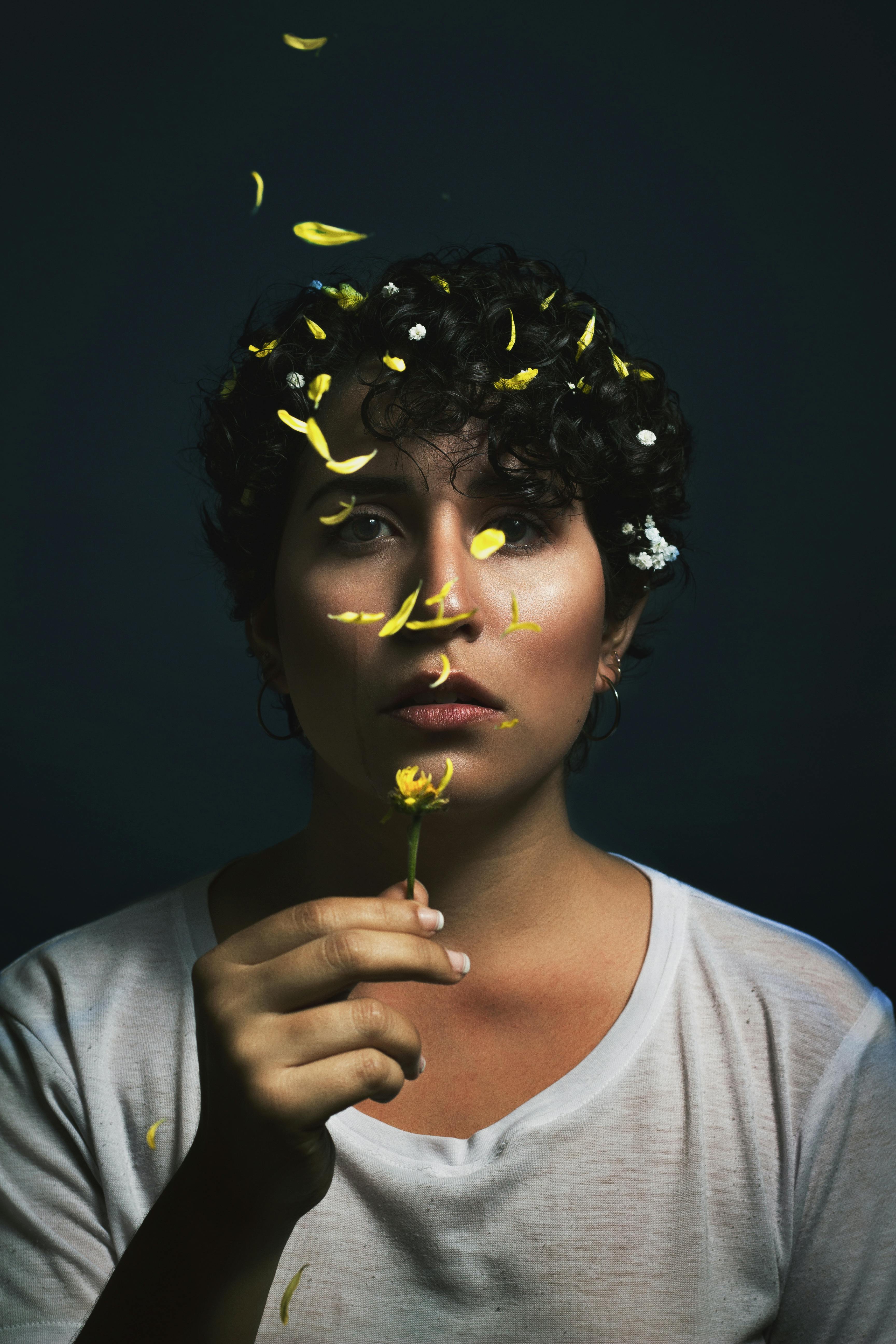 Woman Holding a Yellow Dandelion front of Her Face · Free Stock Photo