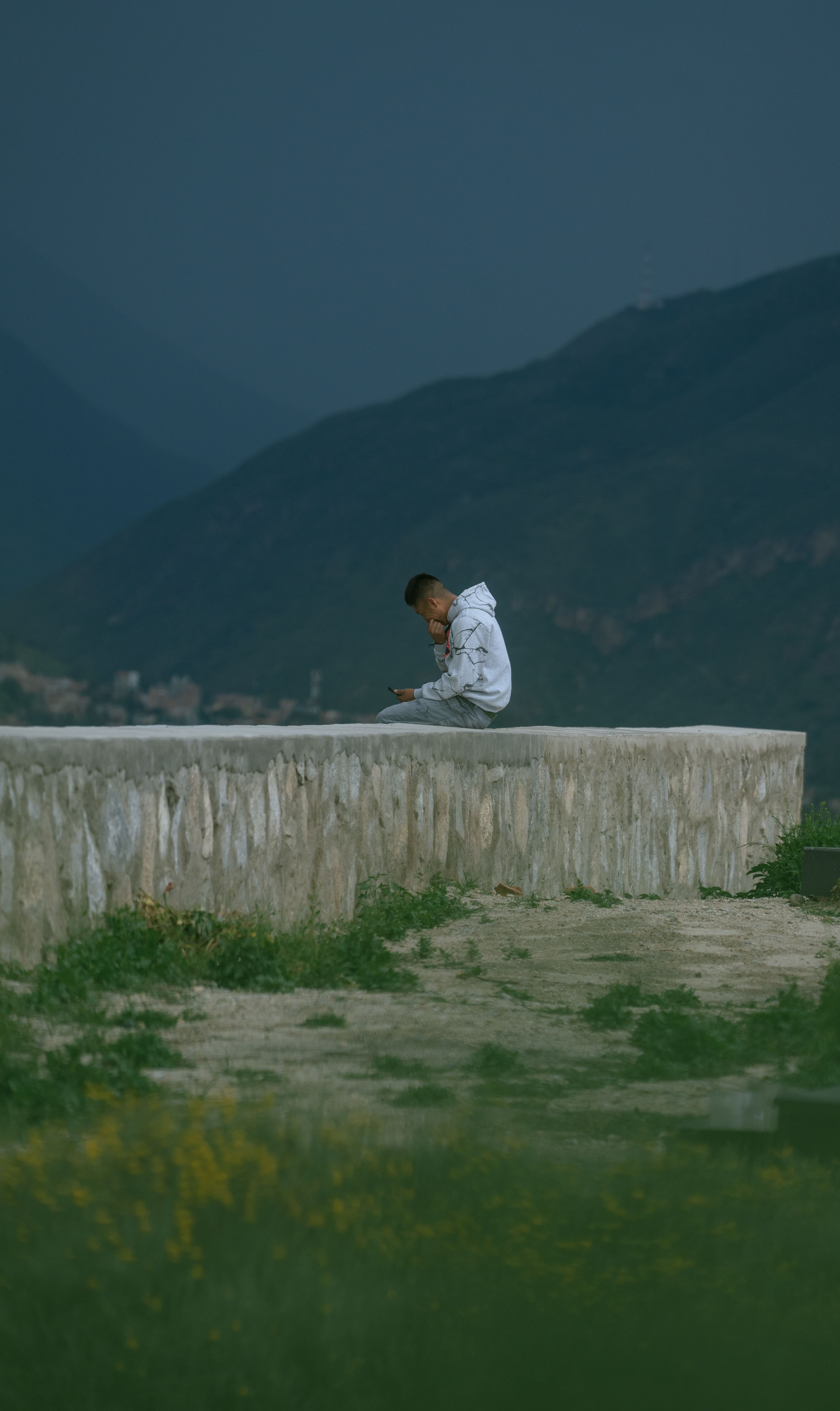 Man Sitting on Wall · Free Stock Photo
