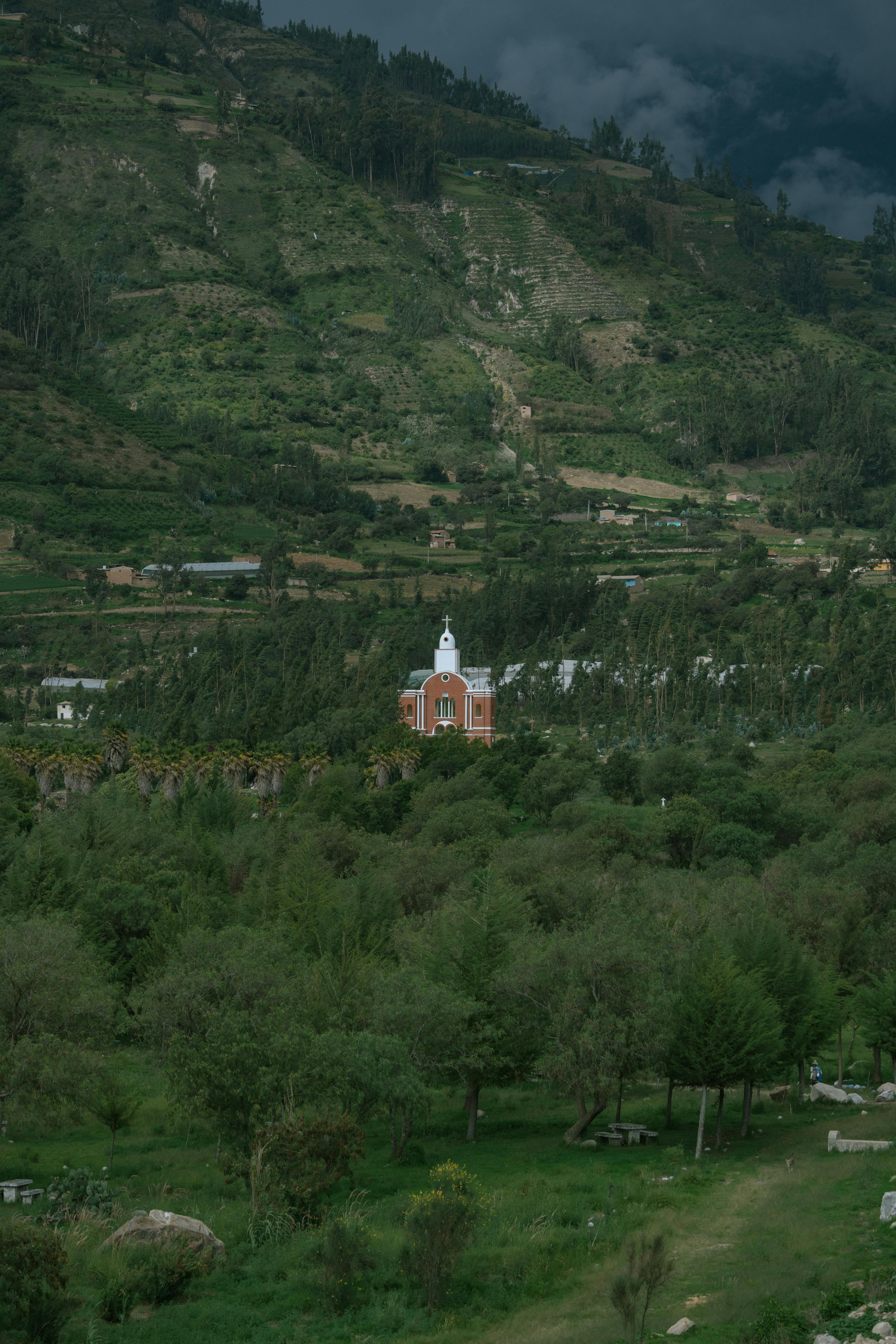 Church in the middle of Valley under Green Mountains · Free Stock Photo