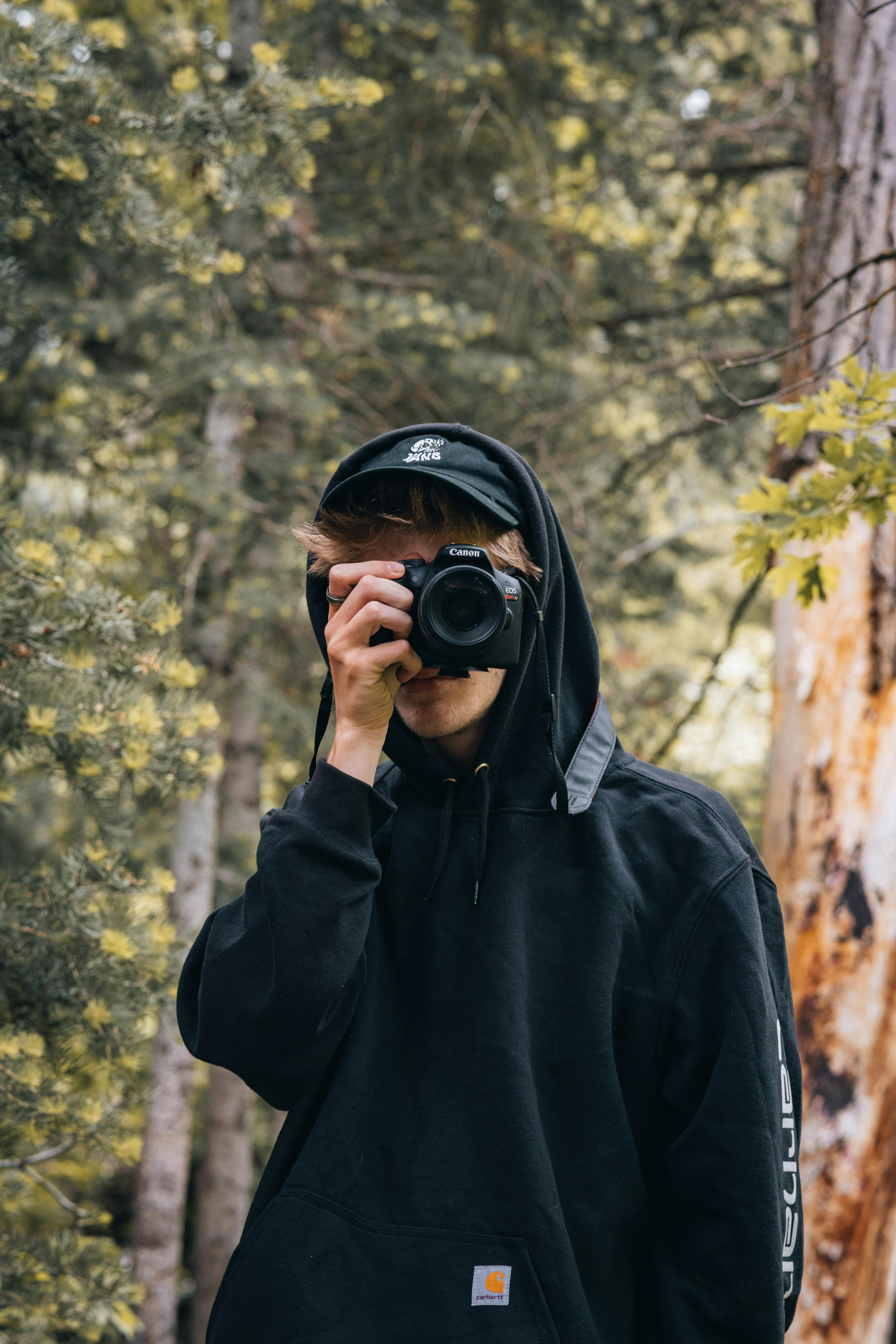 Man Wearing Jacket Holding Dslr Camera · Free Stock Photo