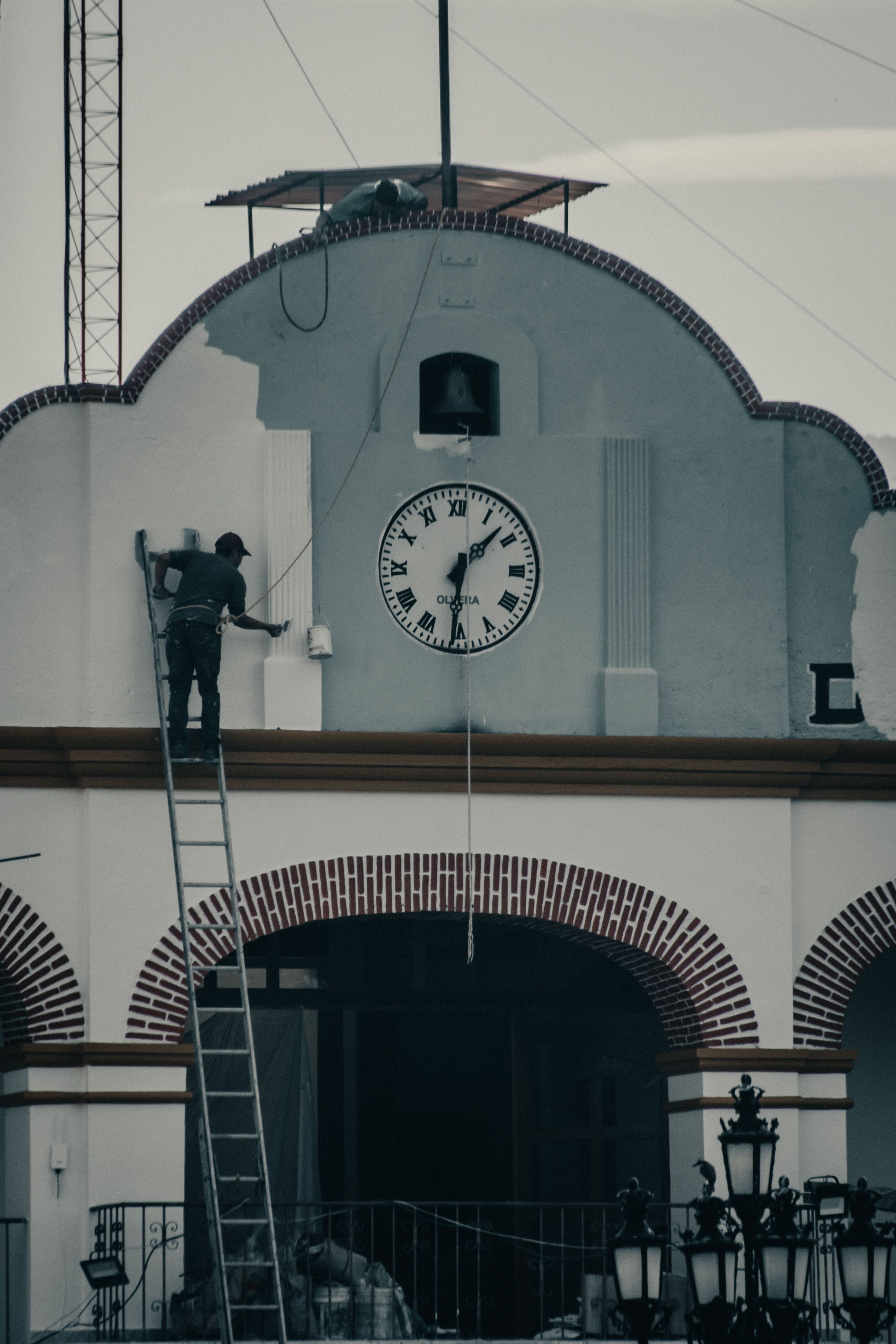 Man Painting Building Wall · Free Stock Photo