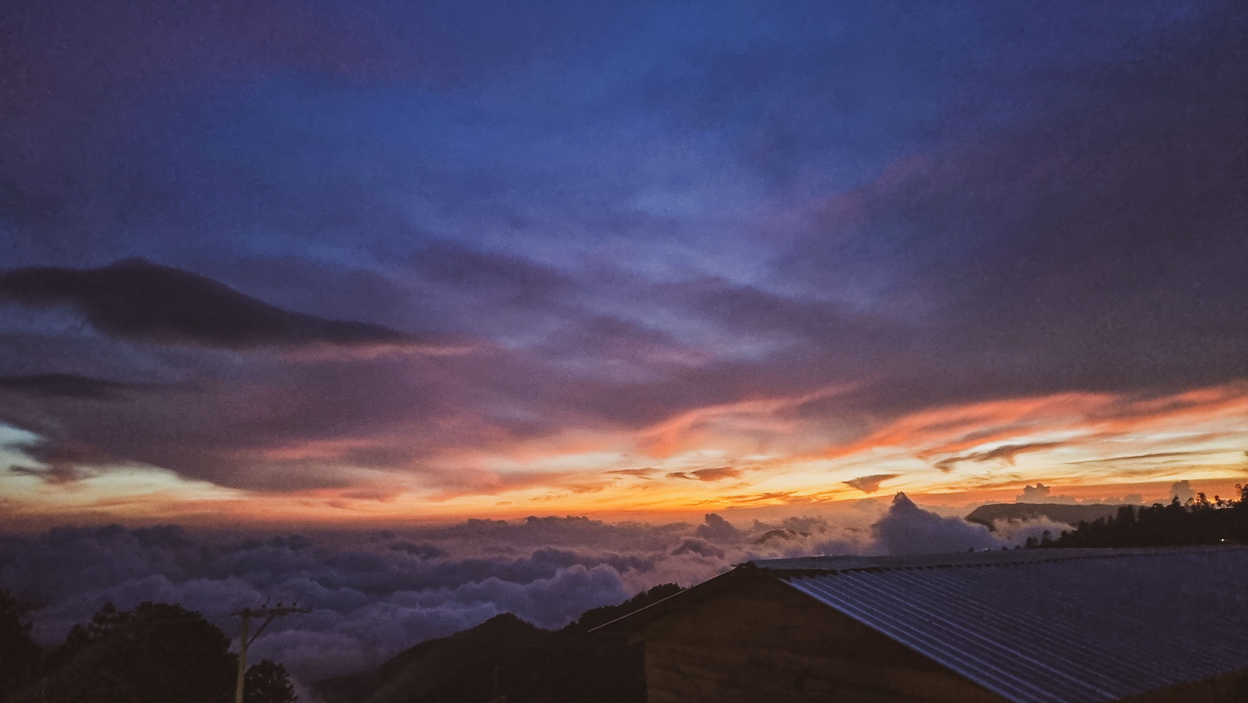 Clouds over Building Roof at Sunset · Free Stock Photo