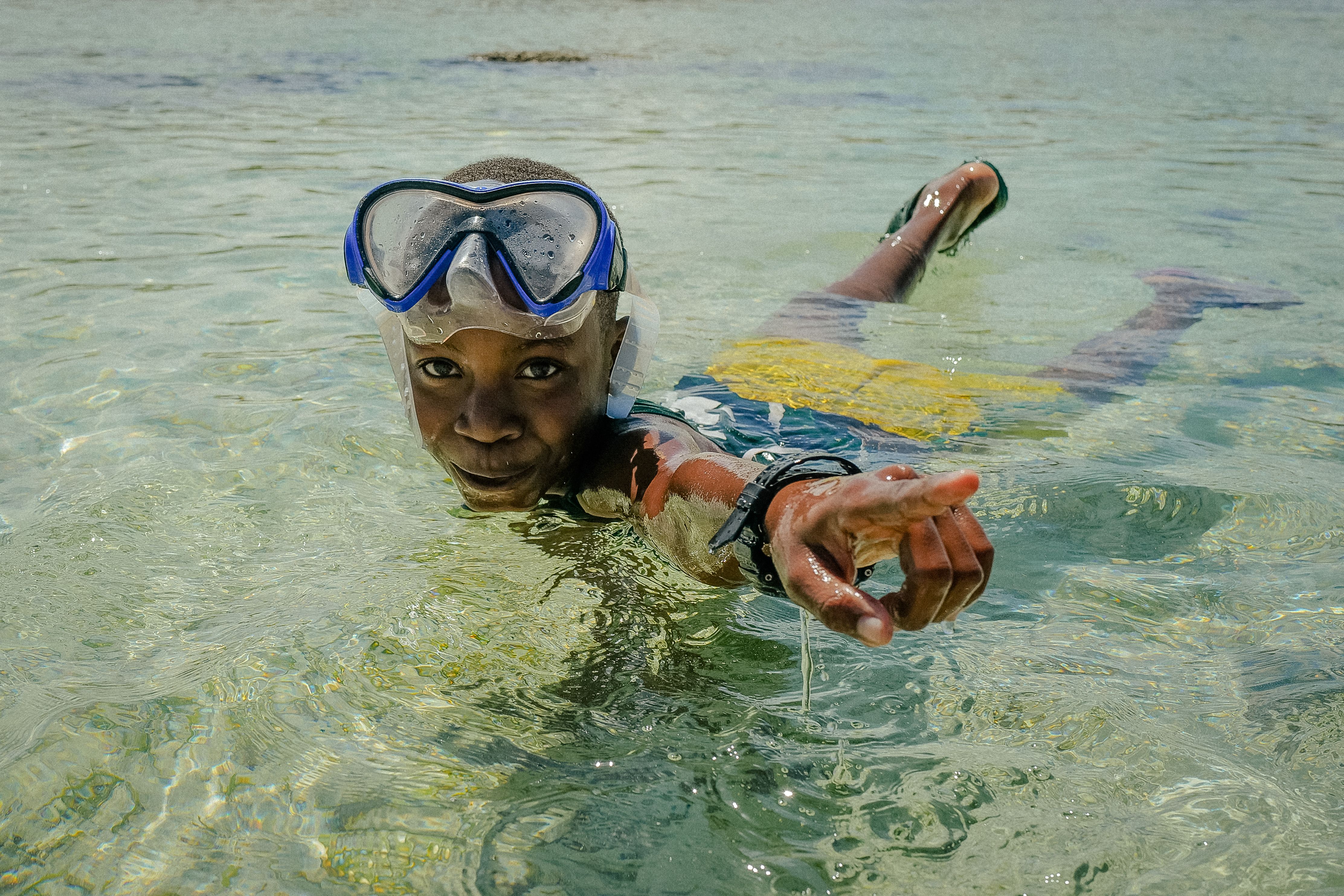 A Boy Wearing a Diving Mask Swimming in the Water · Free Stock Photo