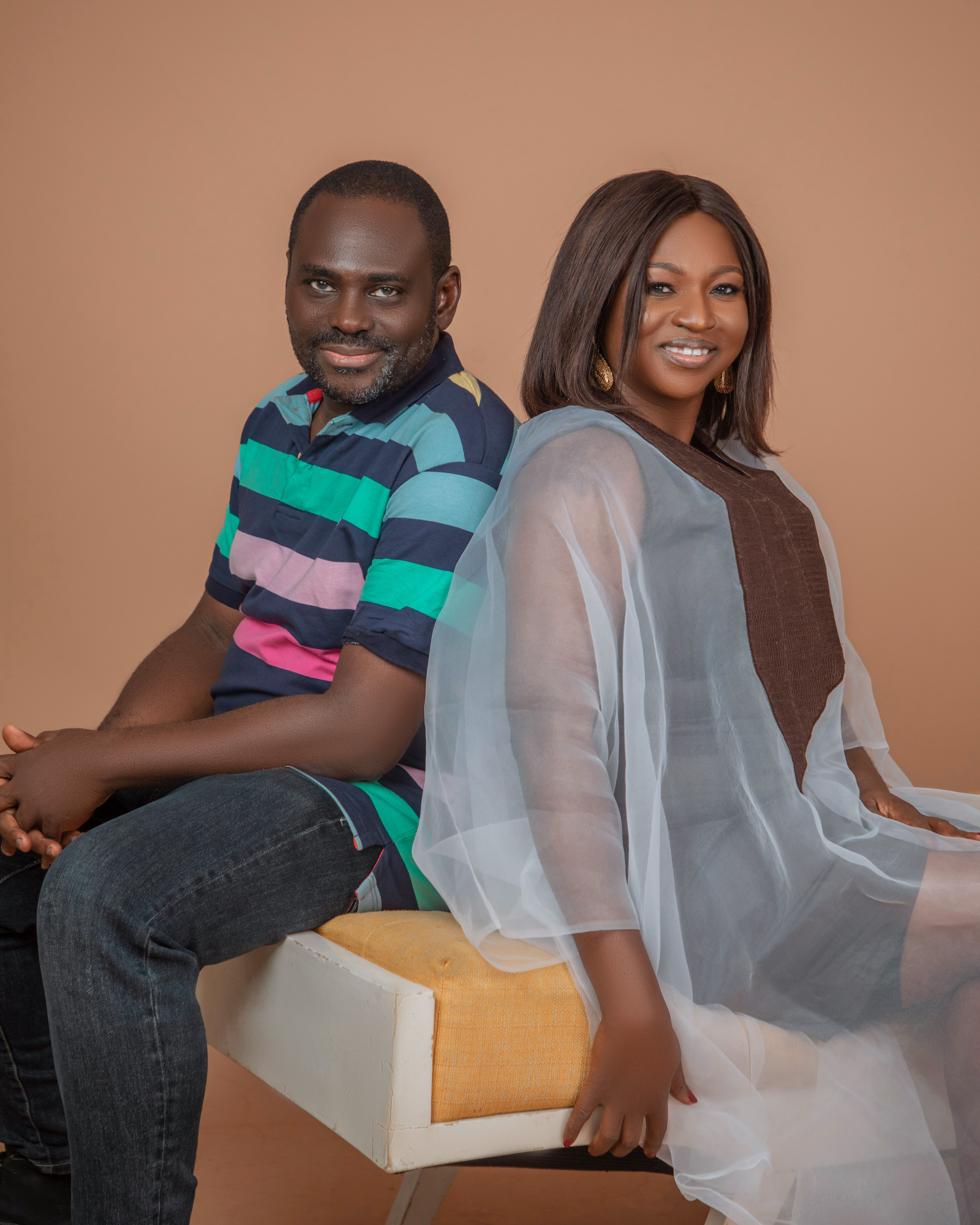 Smiling Couple Sitting and Posing · Free Stock Photo