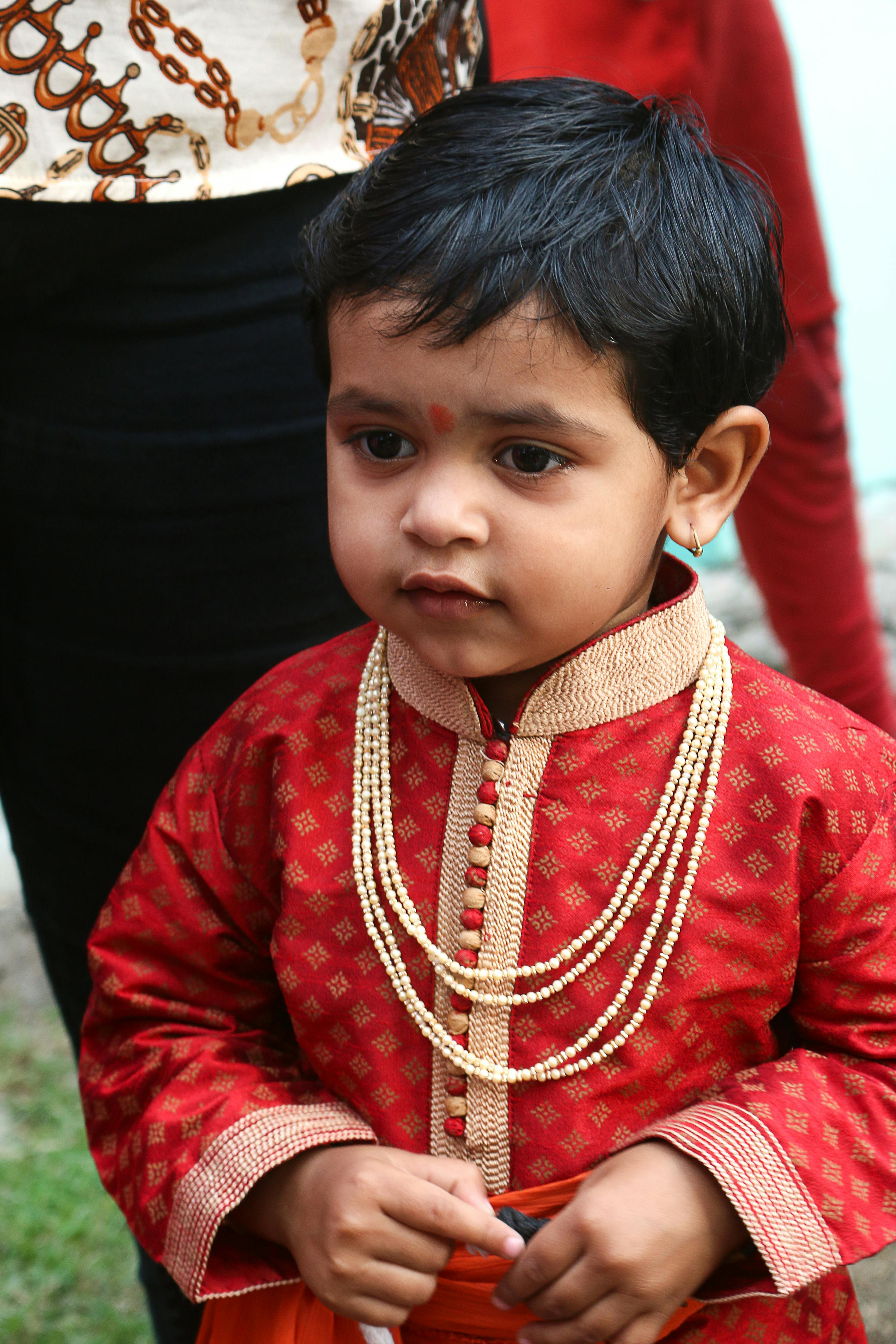 Photo of a Boy Wearing White Traditional Clothing · Free Stock Photo