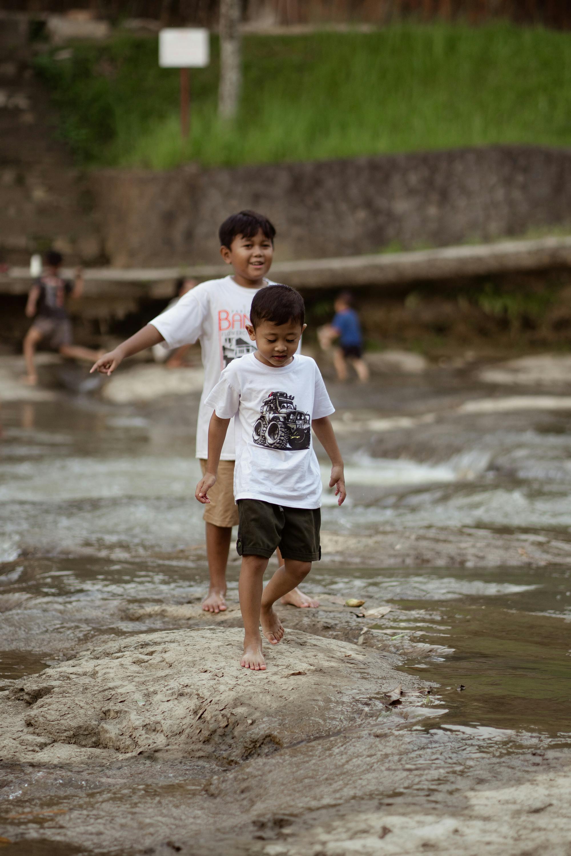 Boys Walking near Water · Free Stock Photo