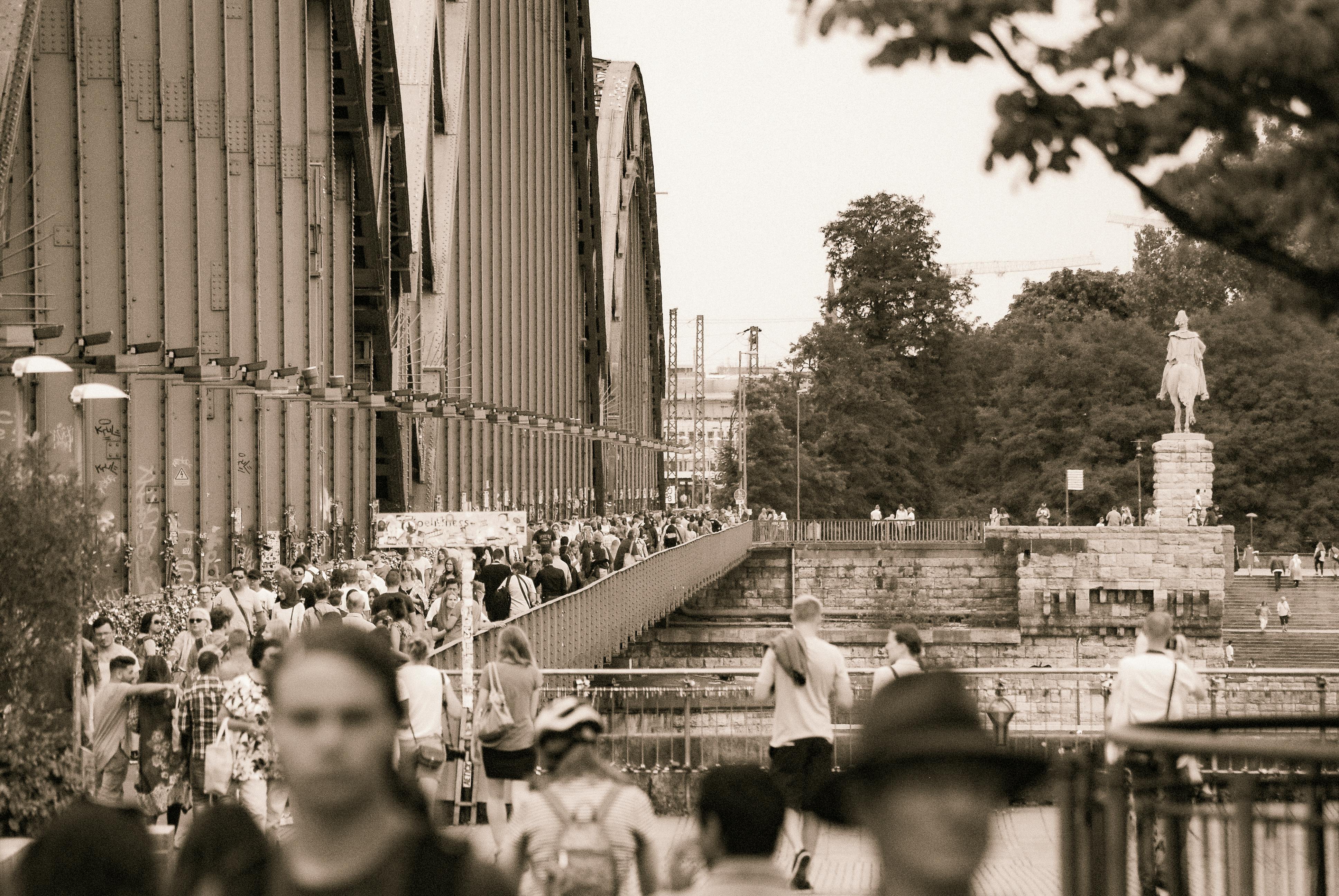 Sepia Toned Photo of a Crowded Bridge near a Building · Free Stock Photo
