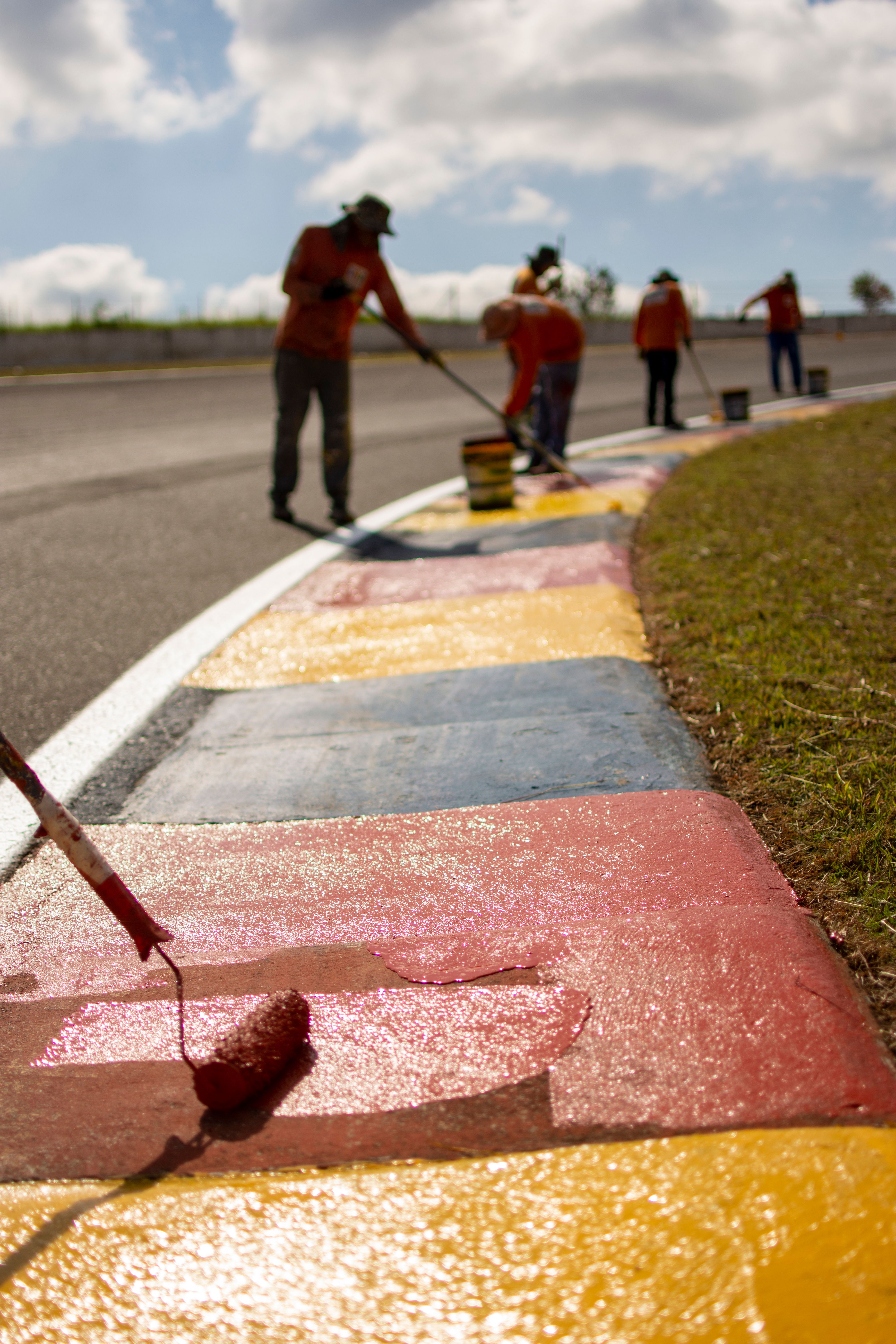 People Painting a Pavement in Sunlight · Free Stock Photo