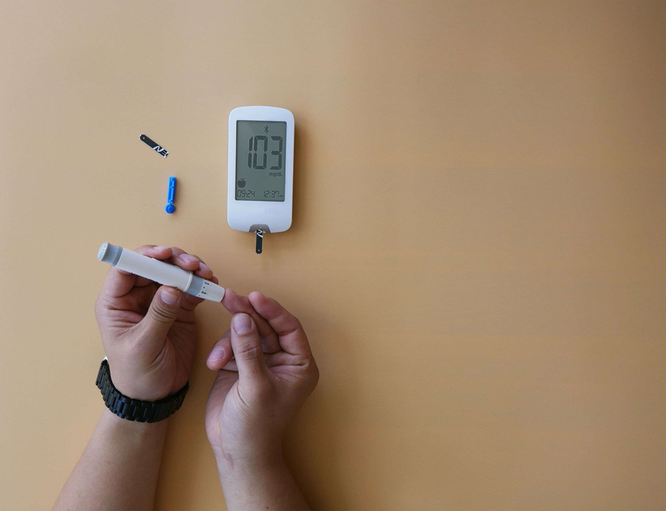 Person Holding a Glucose Meter · Free Stock Photo