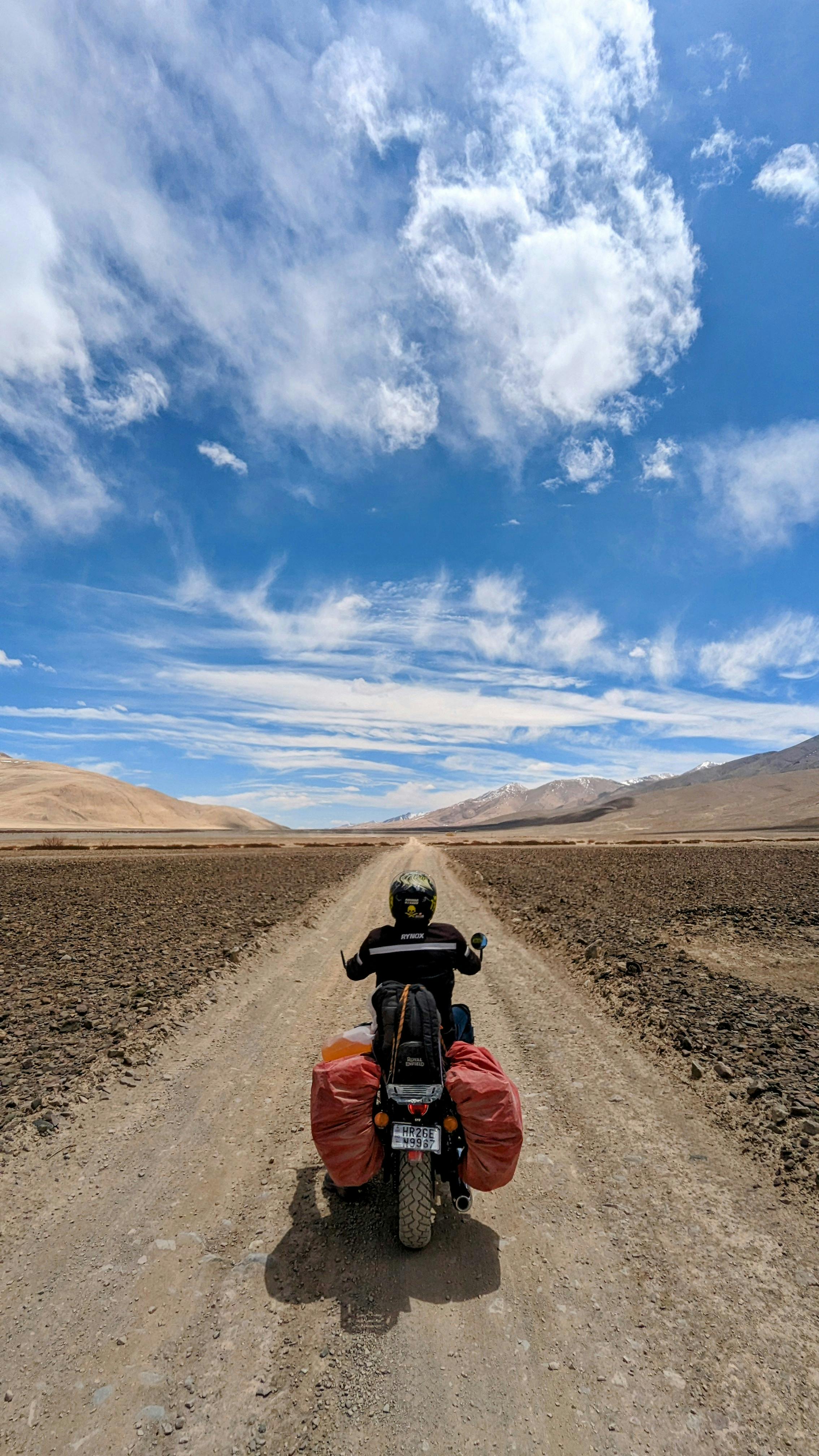 Man Riding a Motorcycle in a Desert · Free Stock Photo