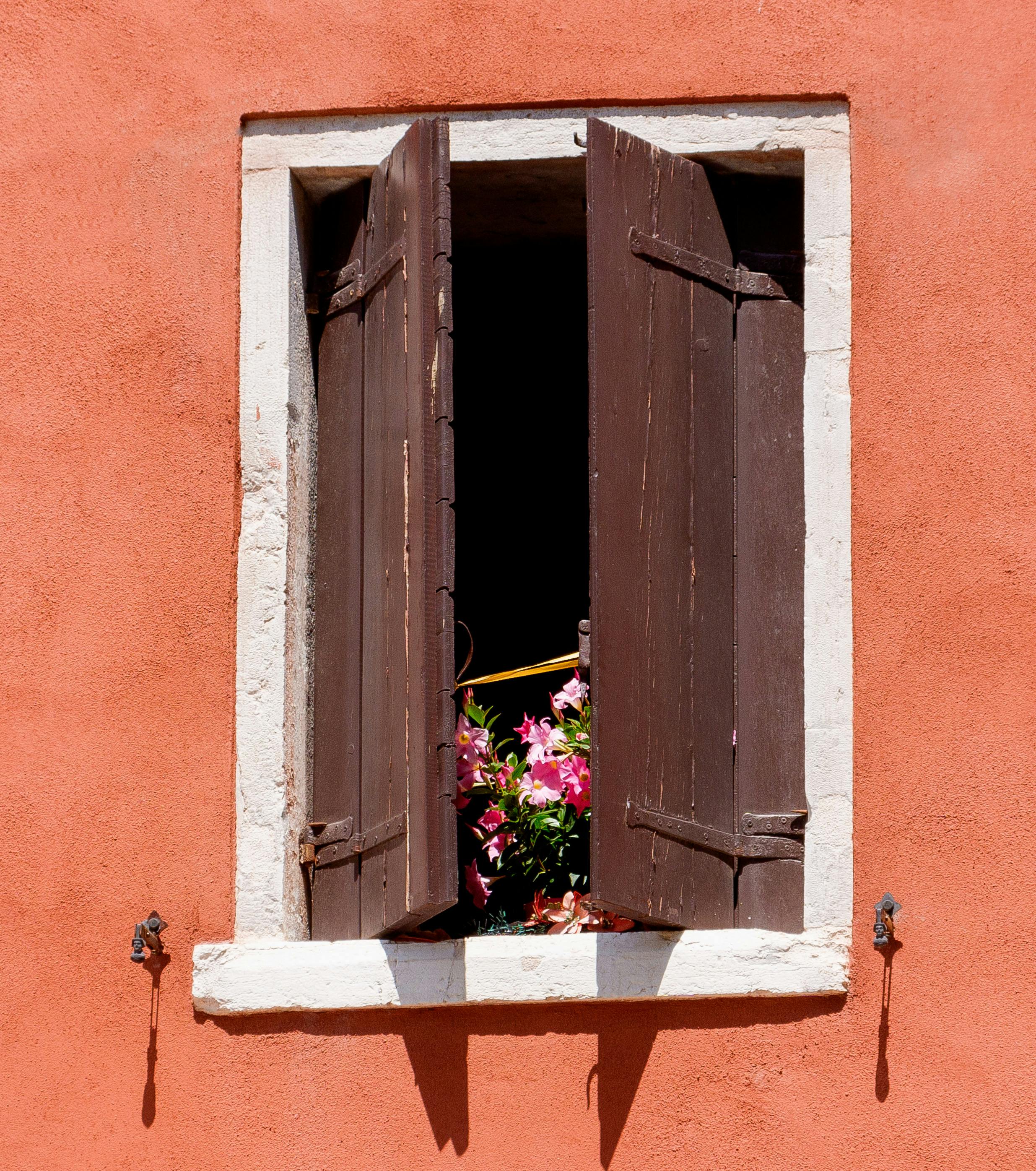 Shuttered Windows of an Orange Painted House · Free Stock Photo