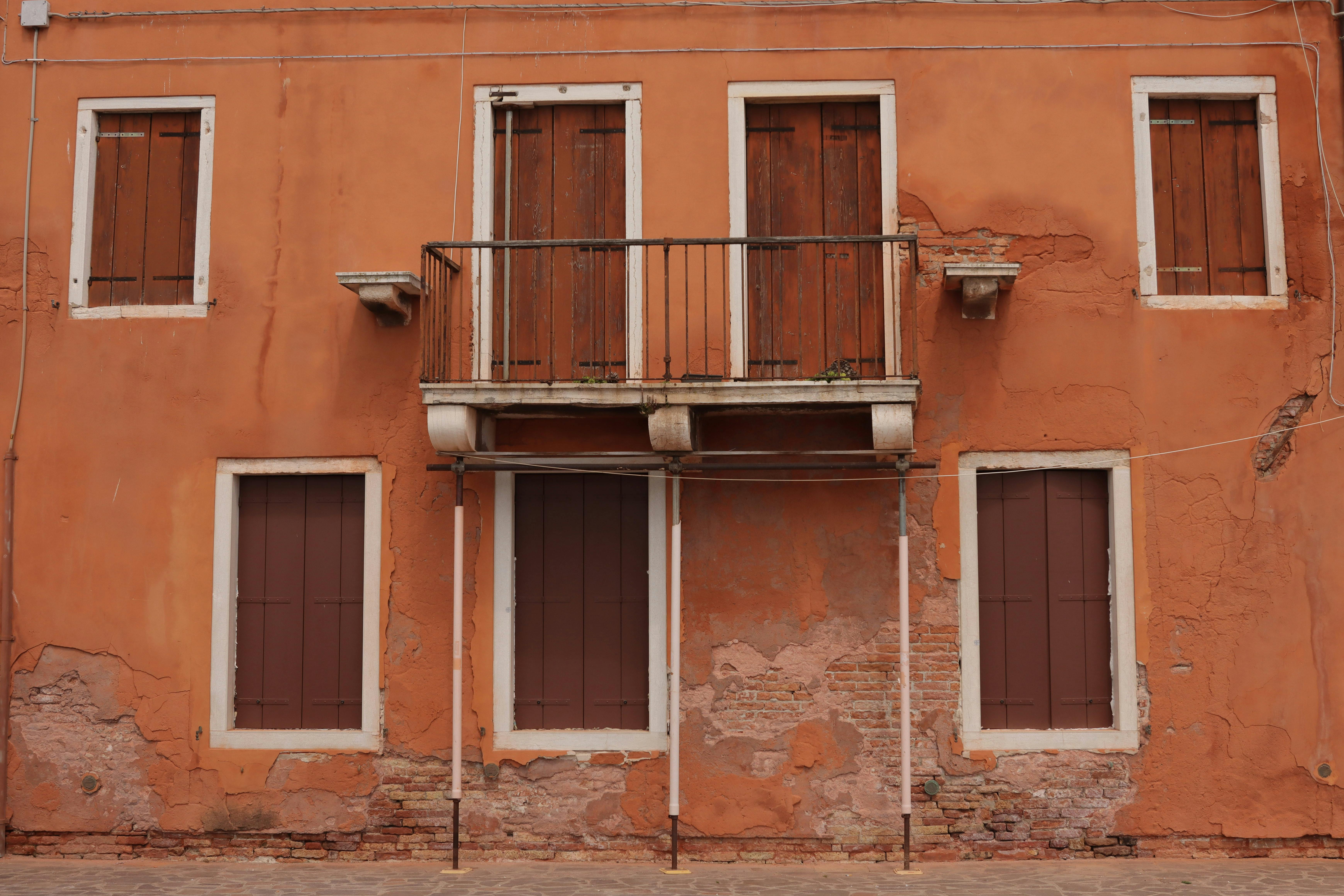 Historical old building with small balconies · Free Stock Photo