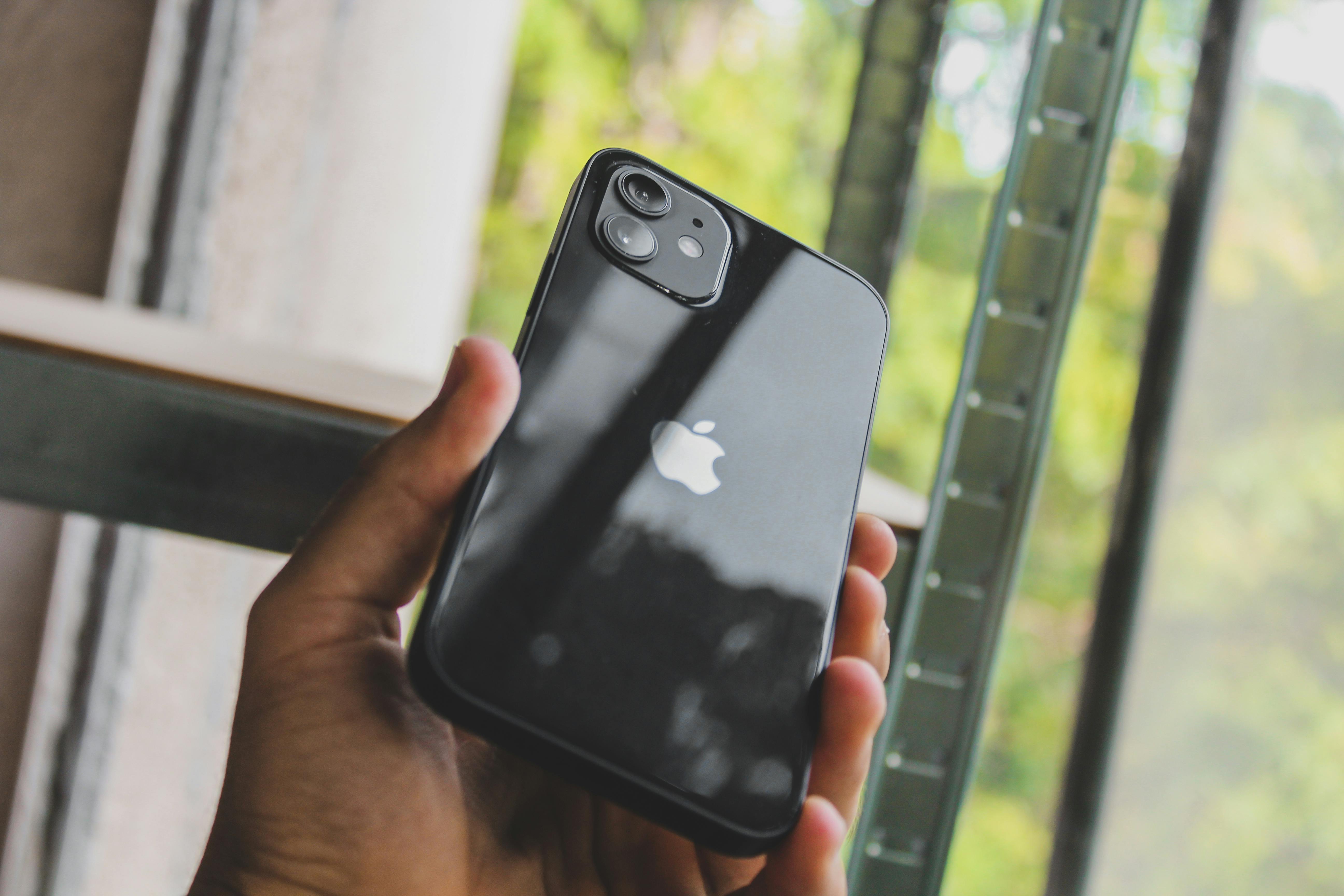 Hand Holding an iPhone · Free Stock Photo