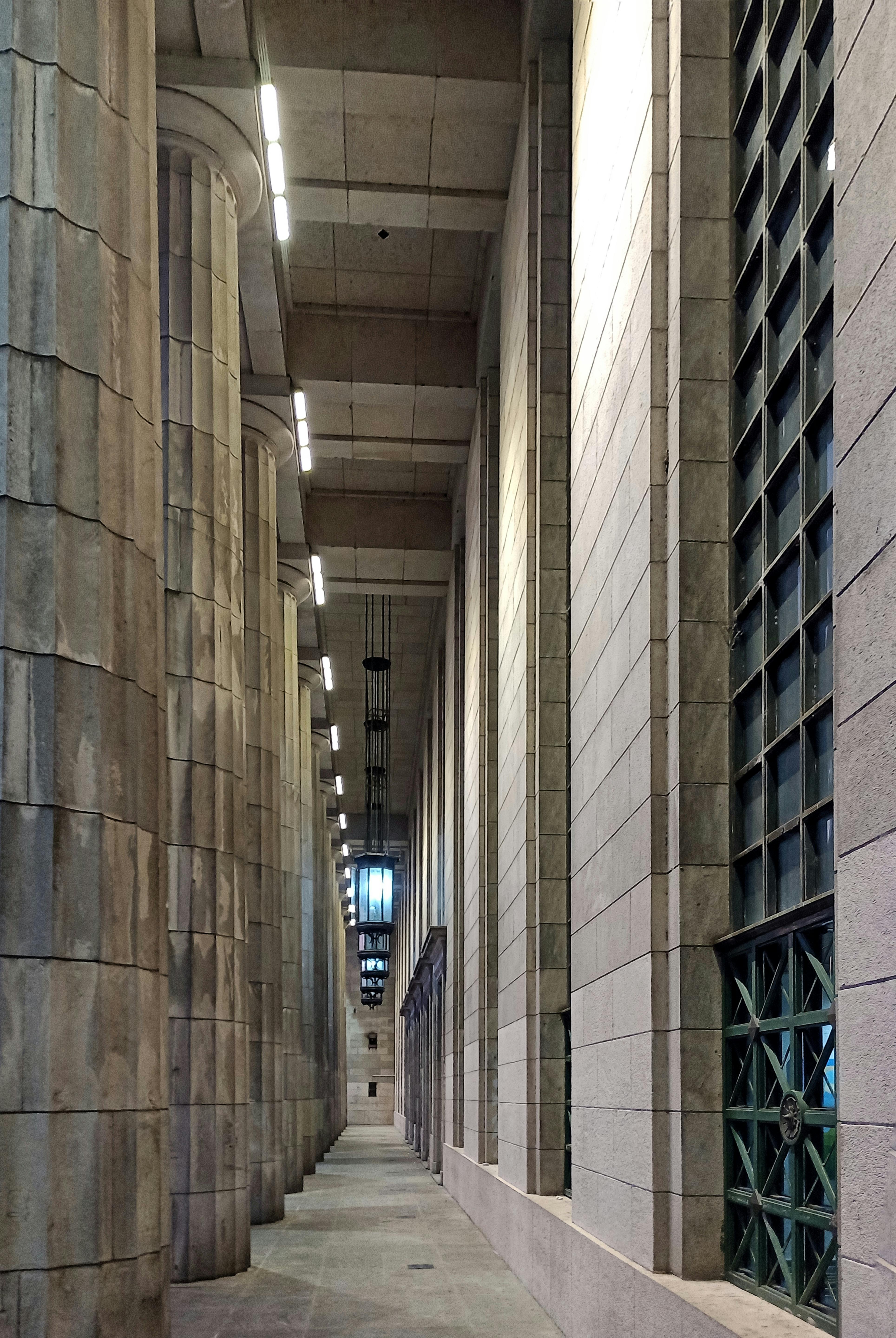 A Narrow Passage between Concrete Wall and Columns · Free Stock Photo