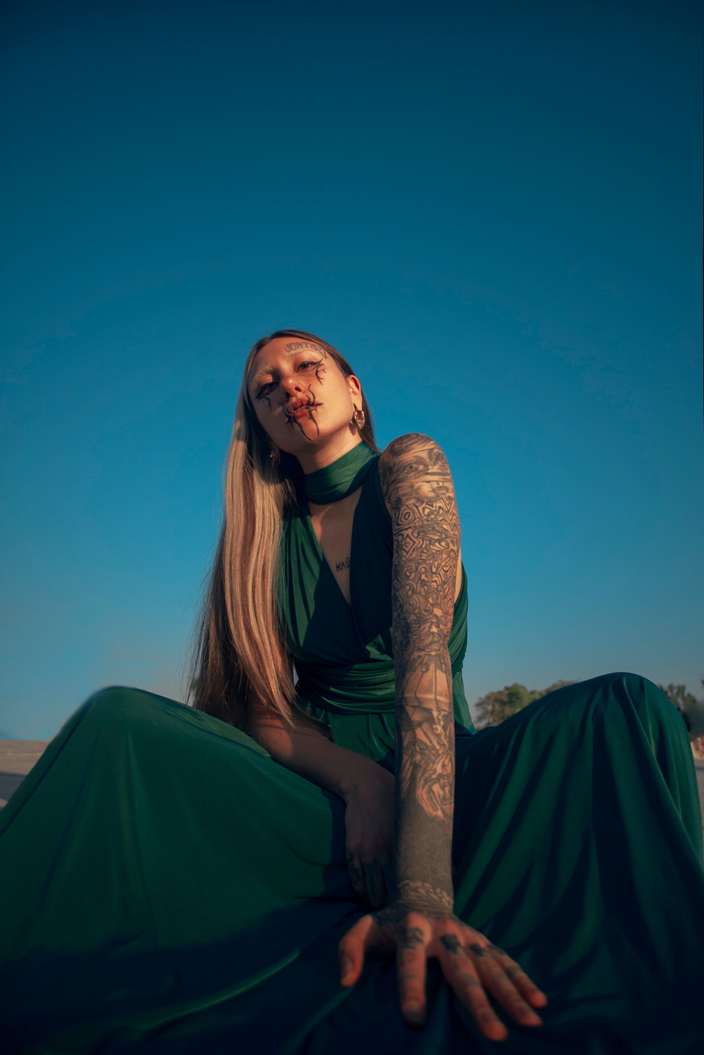 Woman with Tattoos Sitting and Posing · Free Stock Photo