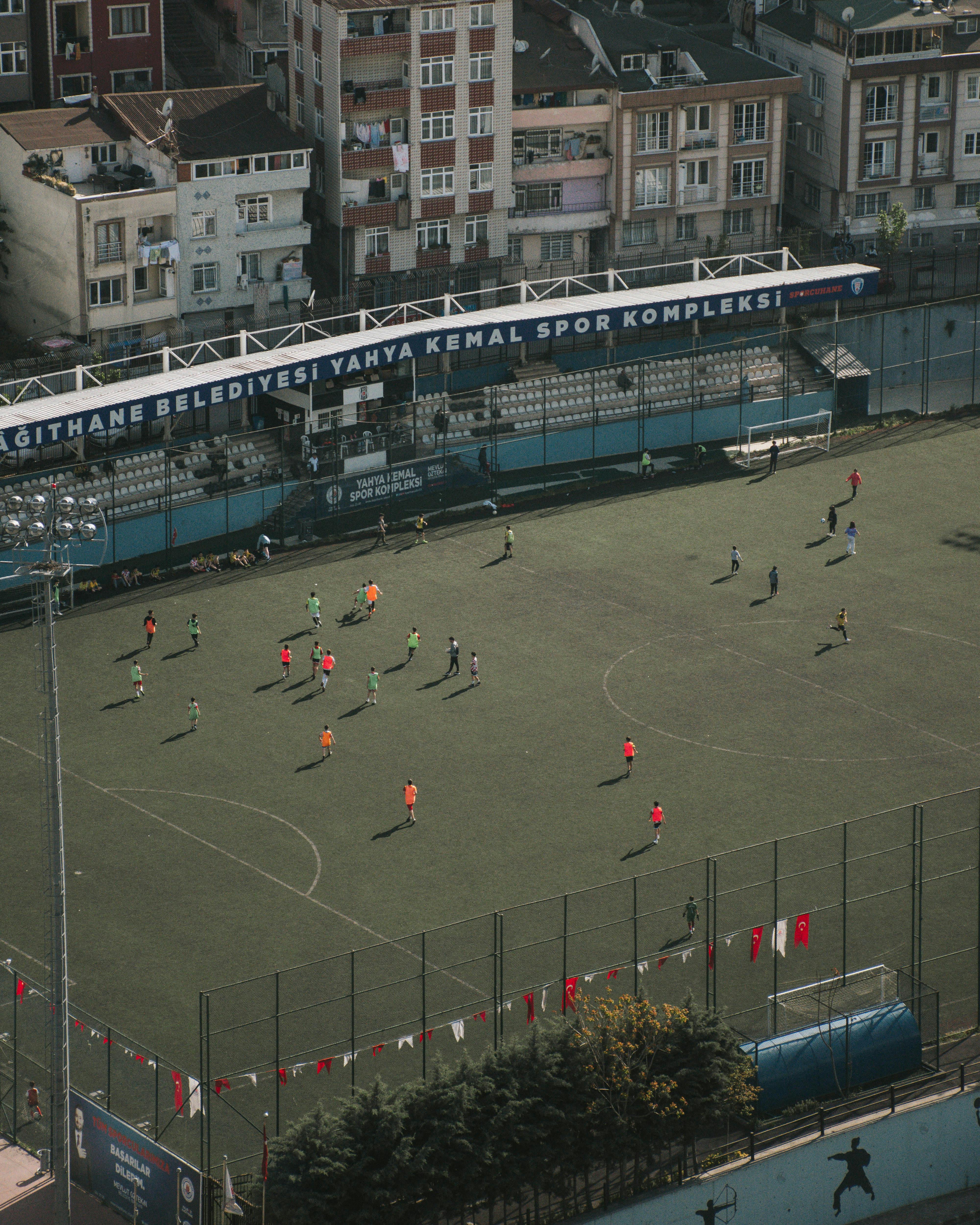 Athletes Playing on Football Pitch · Free Stock Photo