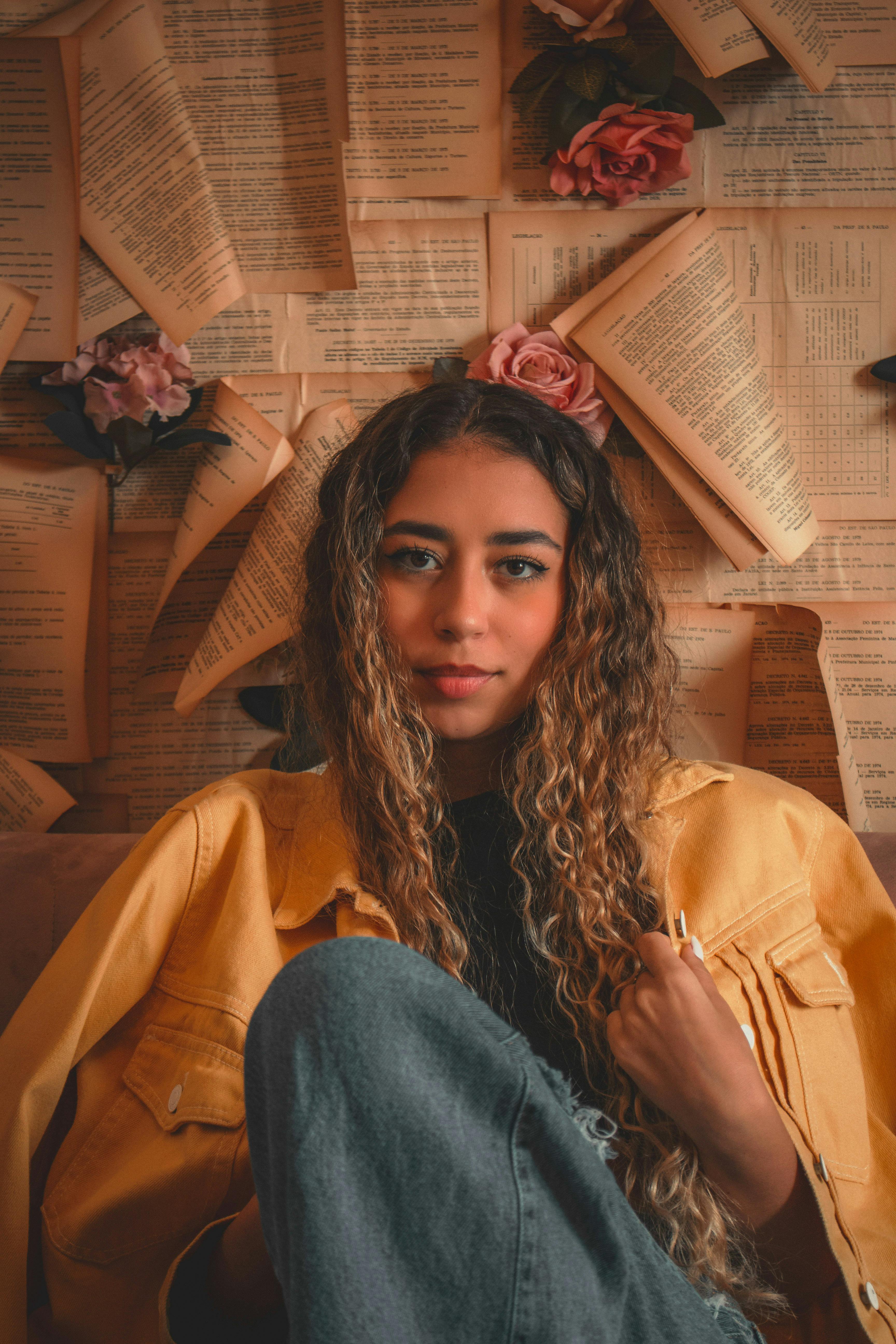 Woman in a Costume and a Crown with Old Yellow Book Pages Flying Around ...
