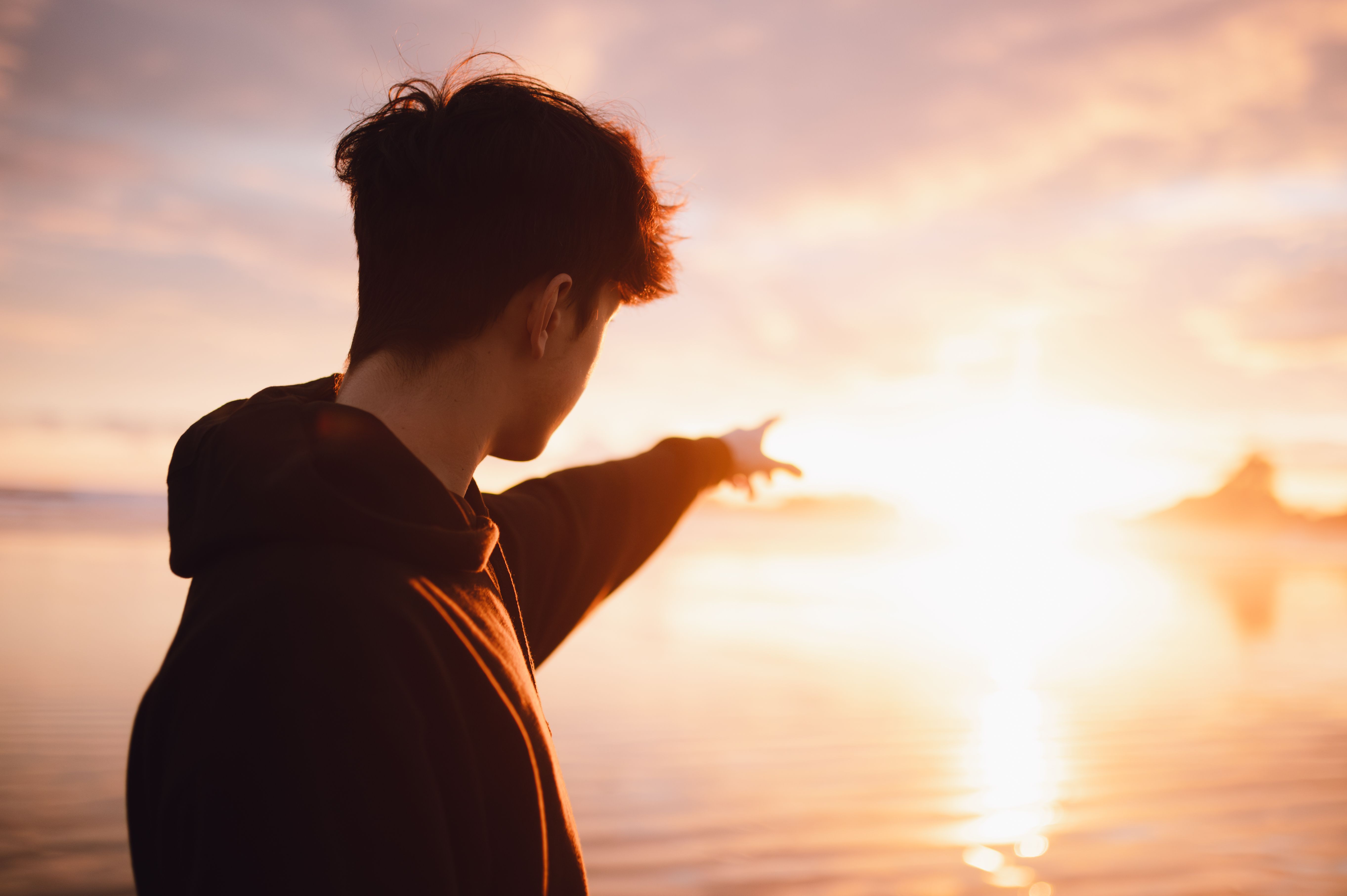 Man Pointing at Sunrise · Free Stock Photo