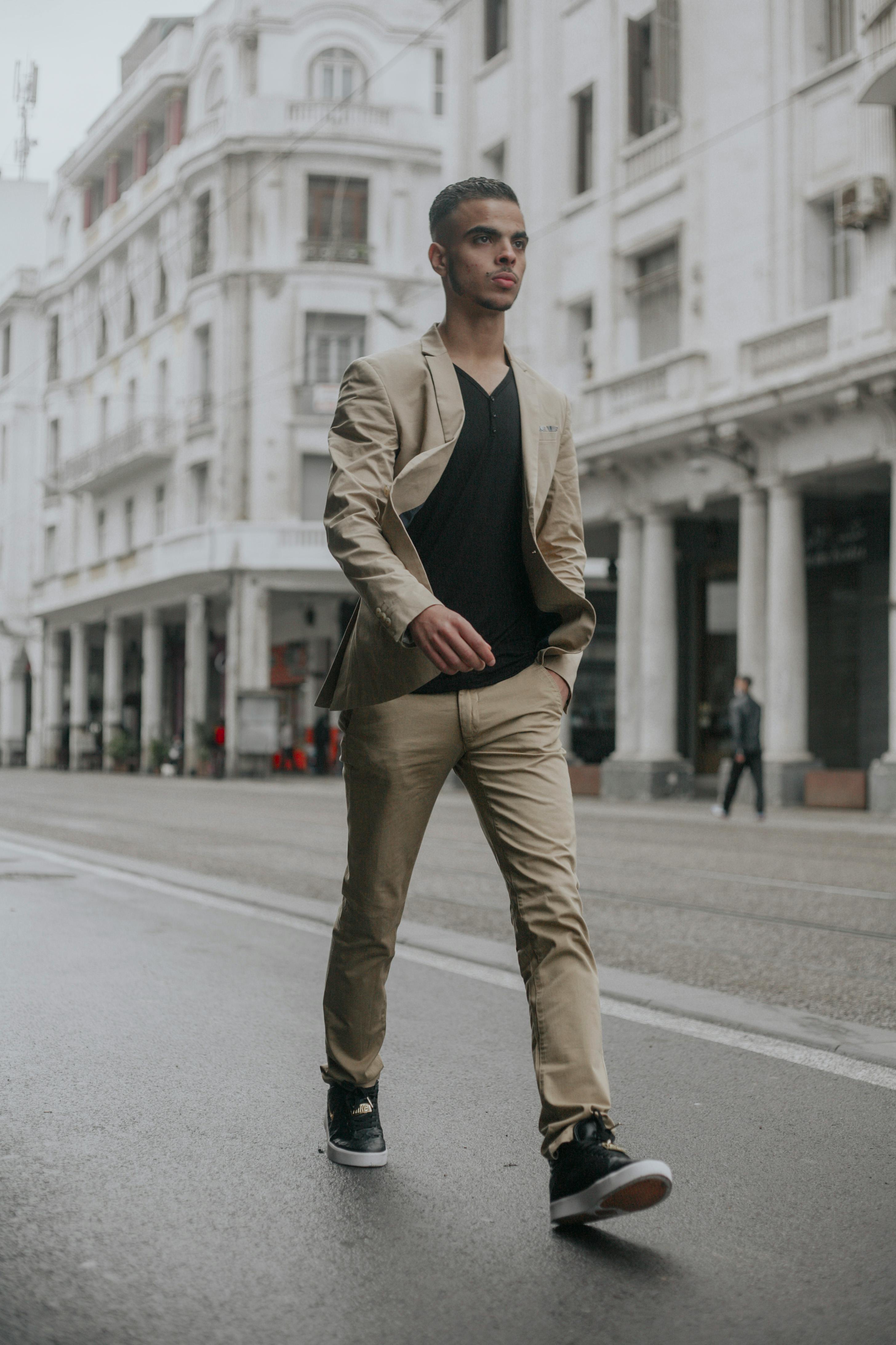 Young Man in a Trendy Outfit Walking in City · Free Stock Photo