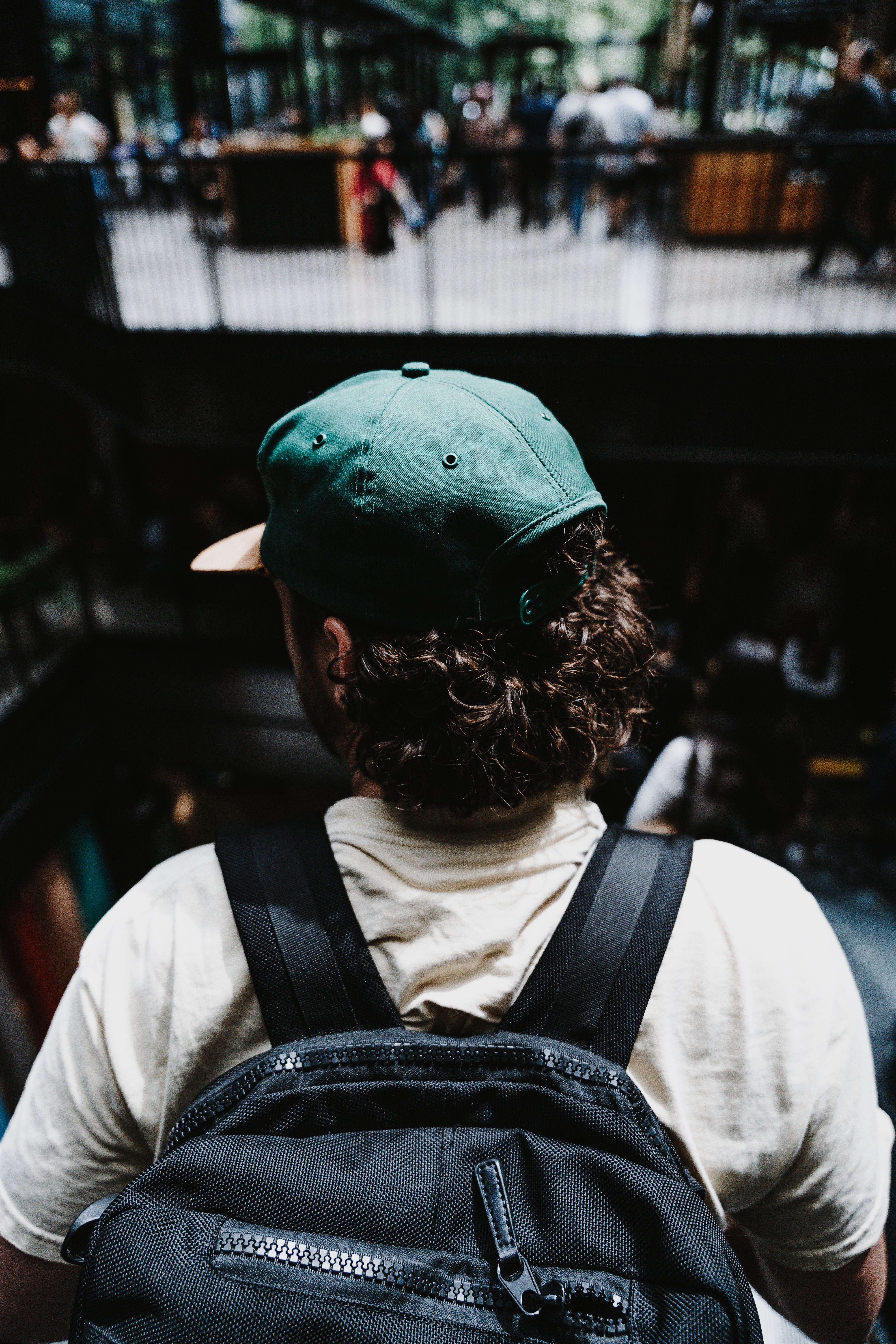 Back View of a Man Wearing a Cap and a Backpack · Free Stock Photo