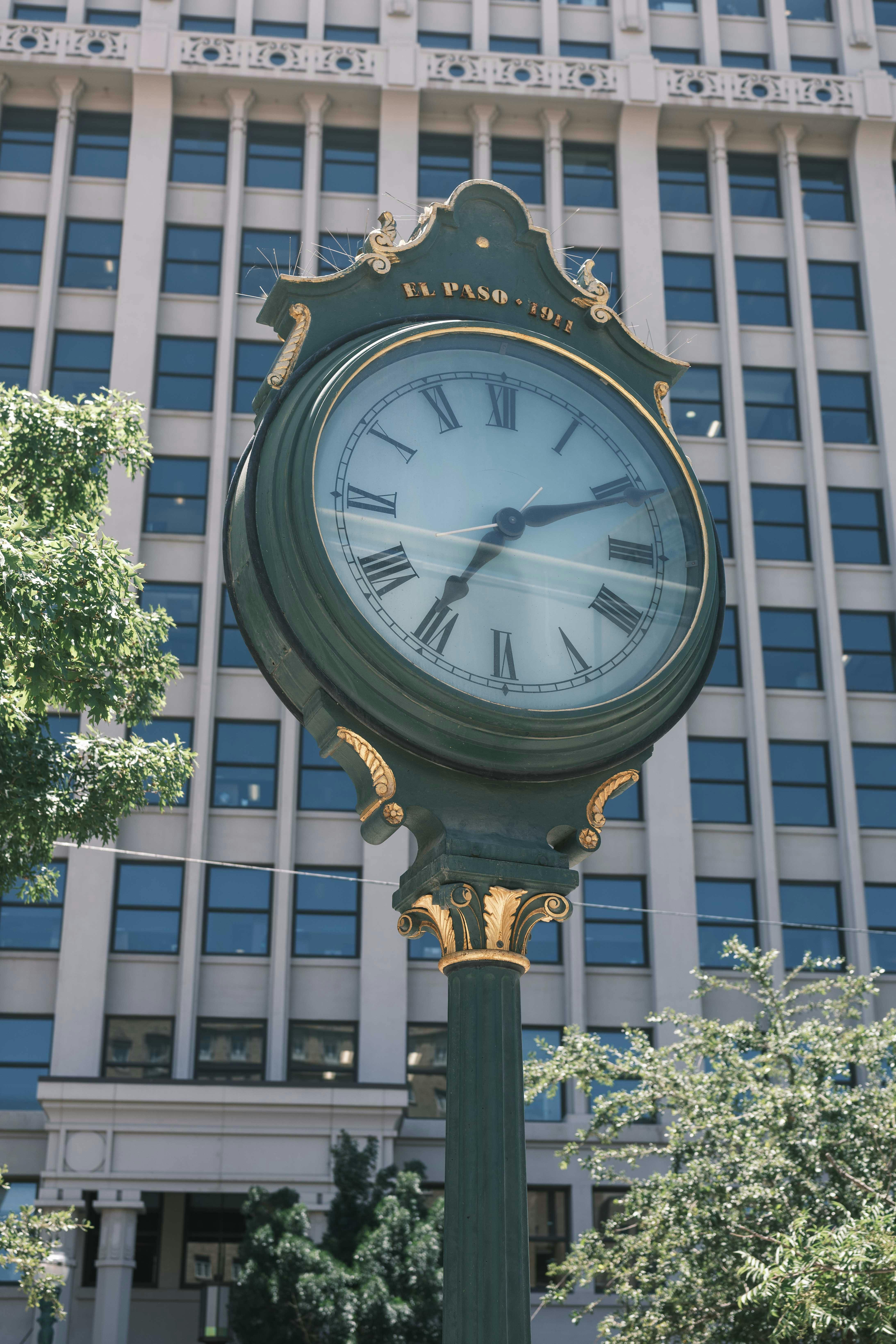 Close-up Photo of Street Clock Near Tall Building · Free Stock Photo