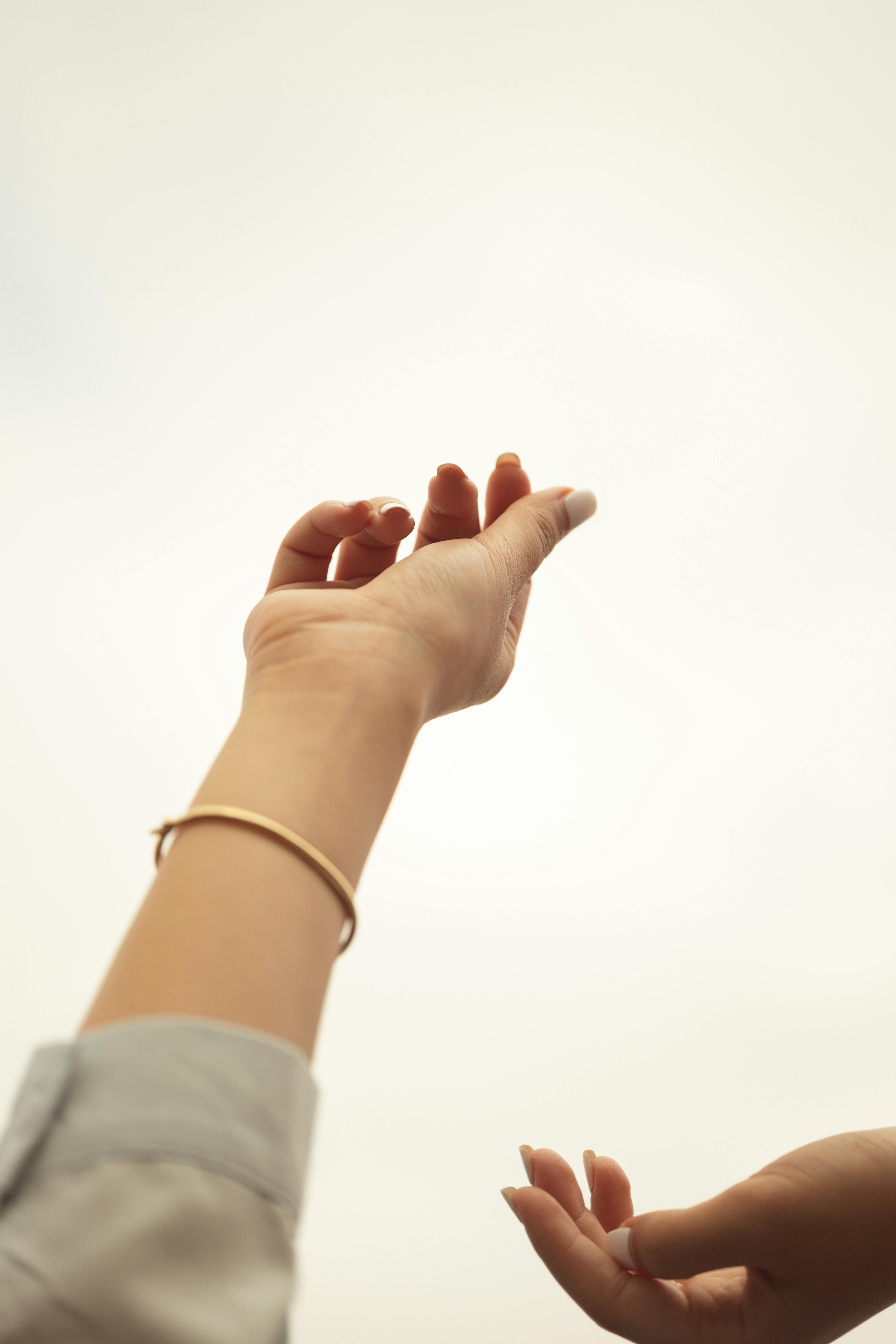 Crop woman with raising hand on white background · Free Stock Photo